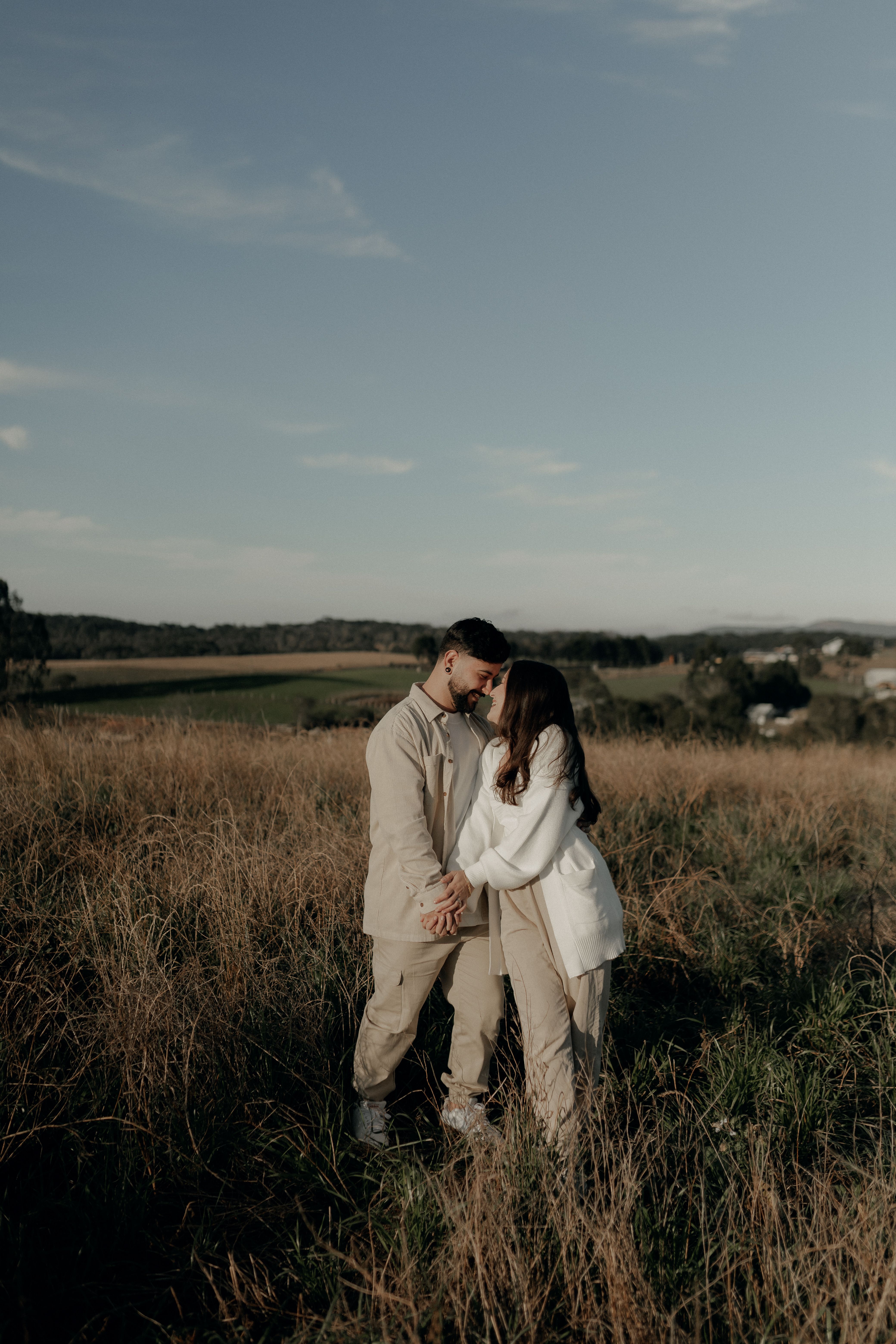 Romantic Couple Embracing in Countryside Field · Free Stock Photo