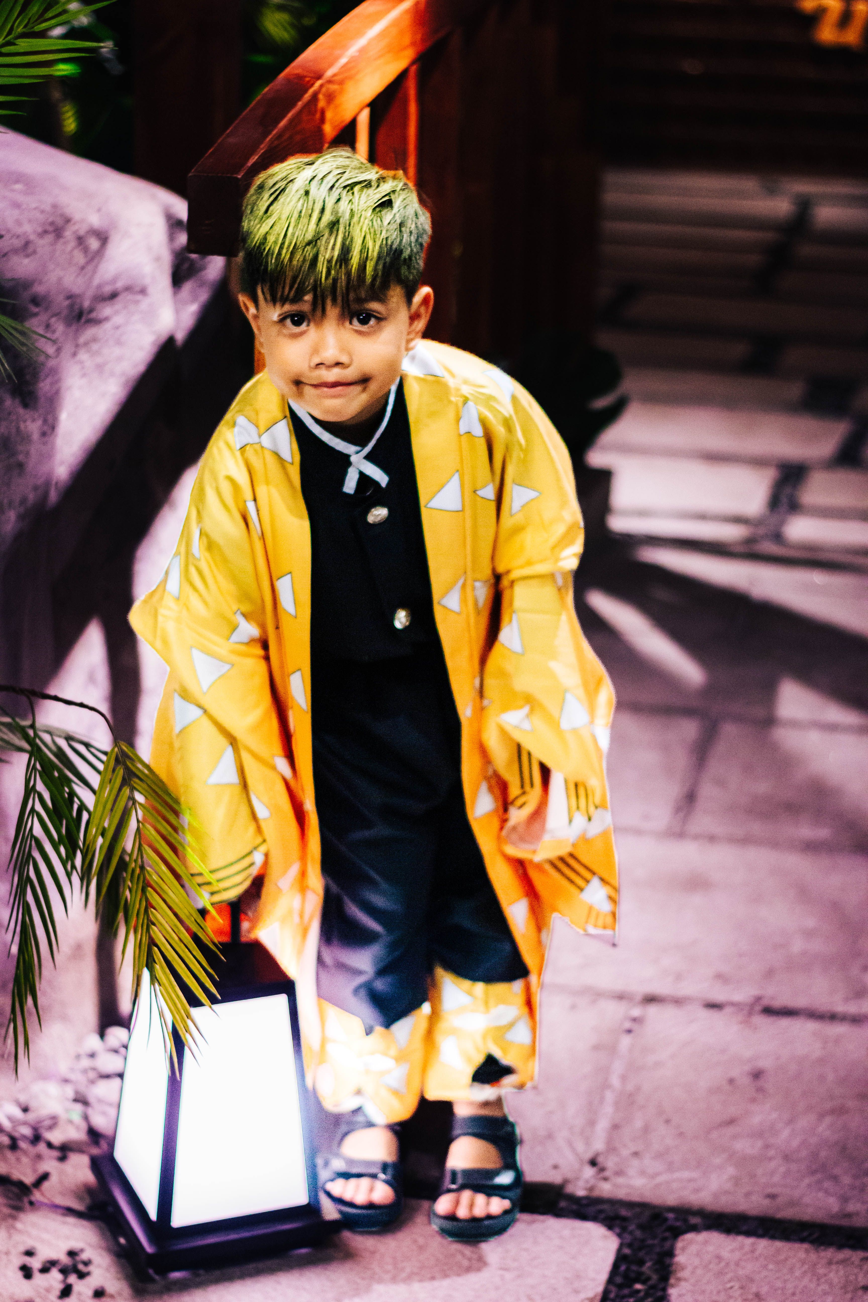 Child in Cosplay Holding Lantern Outdoors · Free Stock Photo