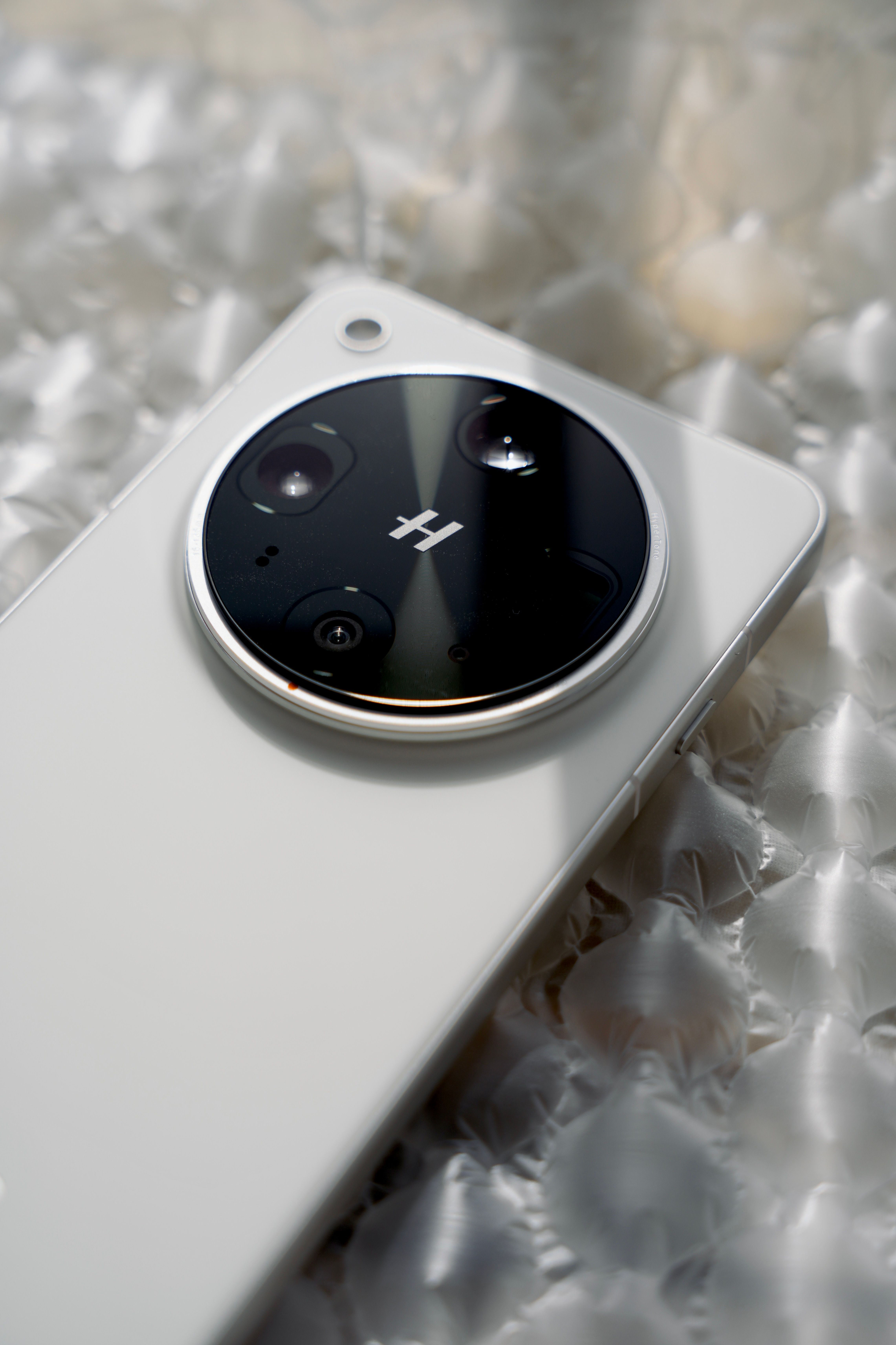 Minimalist White Smartphone on Reflective Surface · Free Stock Photo