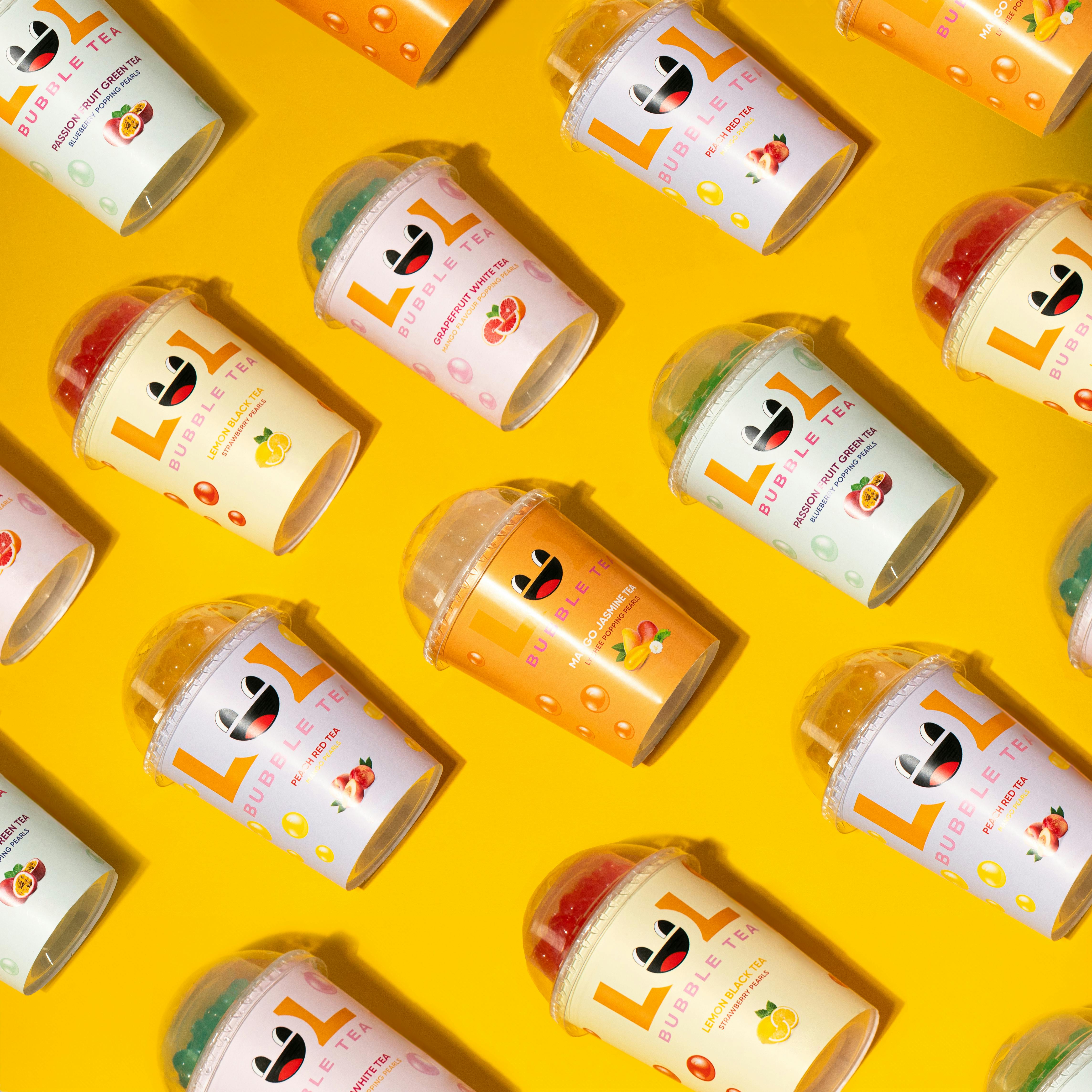 Colorful Bubble Tea Cups on Vibrant Yellow Background · Free Stock Photo