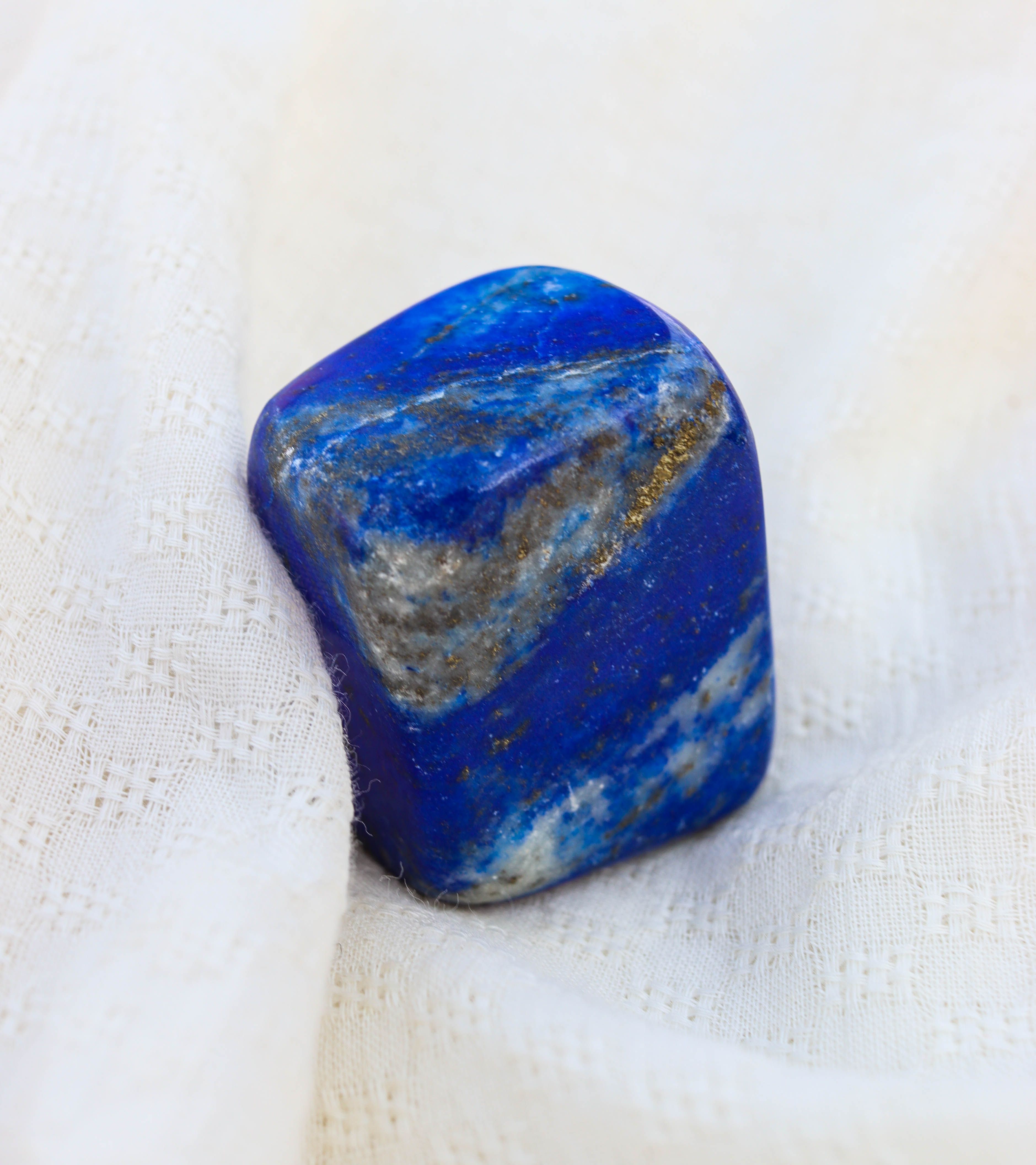 Close-Up of Lapis Lazuli Stone on White Fabric · Free Stock Photo