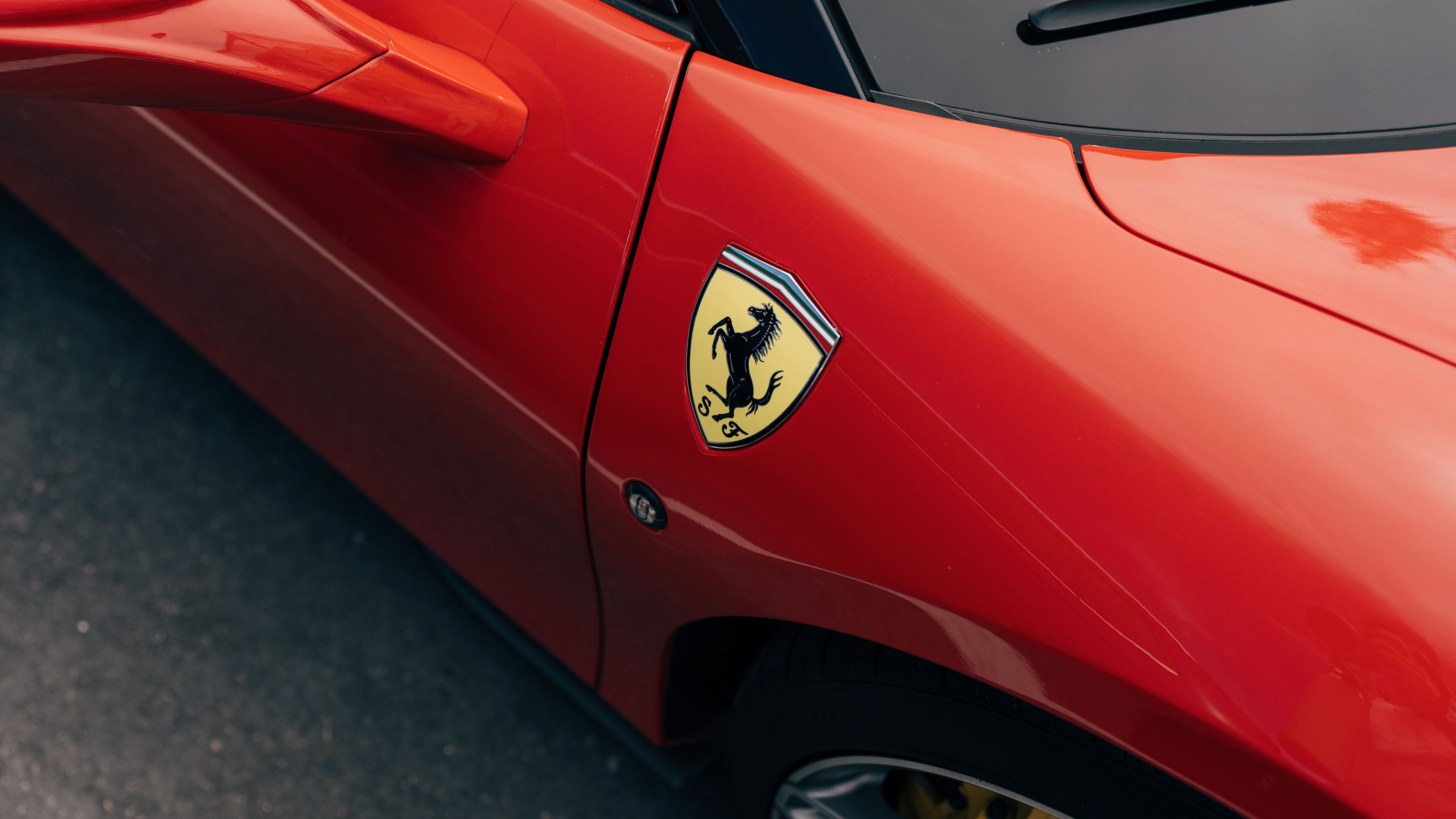Close-up of Red Sports Car with Iconic Emblem · Free Stock Photo