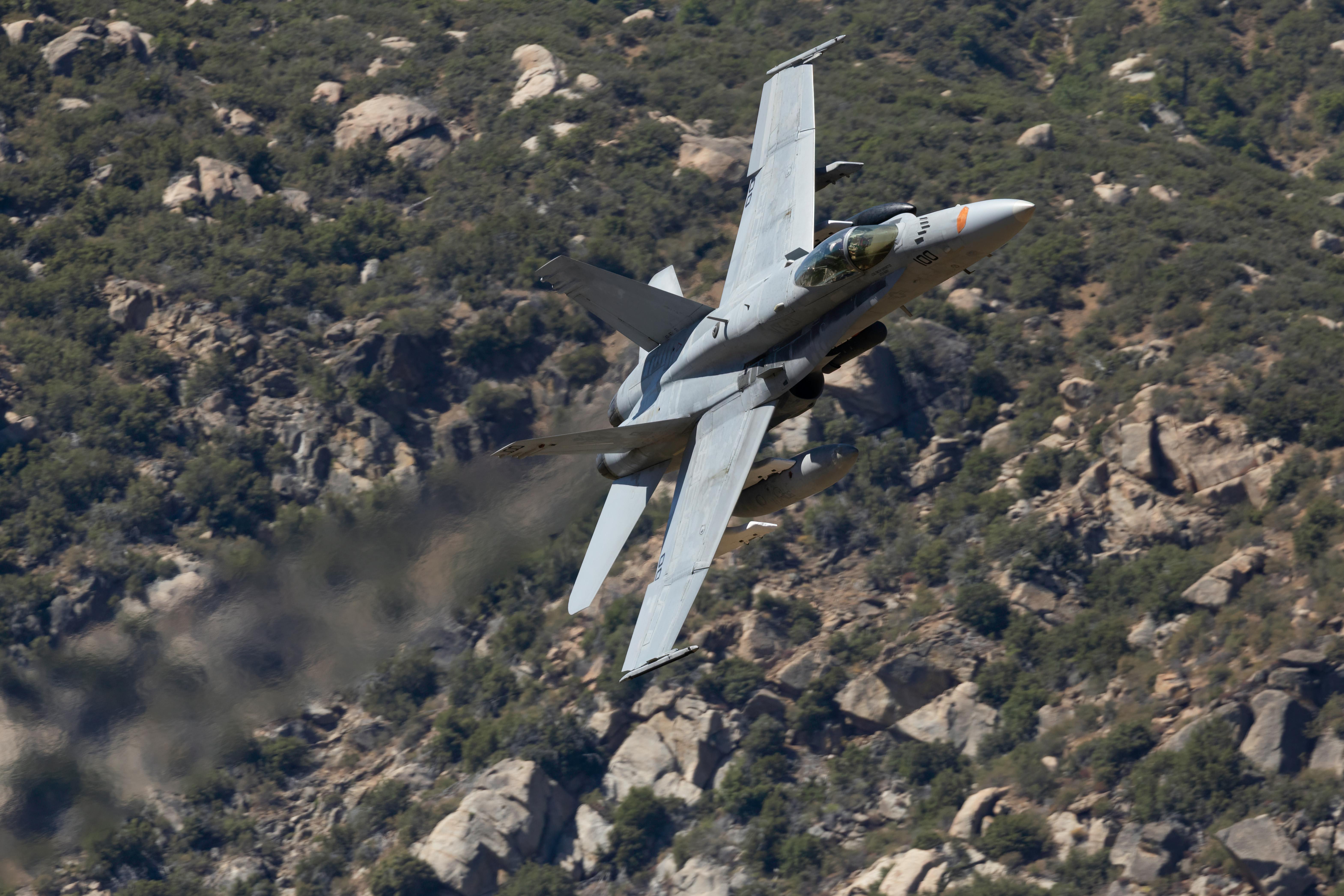 F/A-18 Hornet Flying Over Rocky Terrain in California · Free Stock Photo