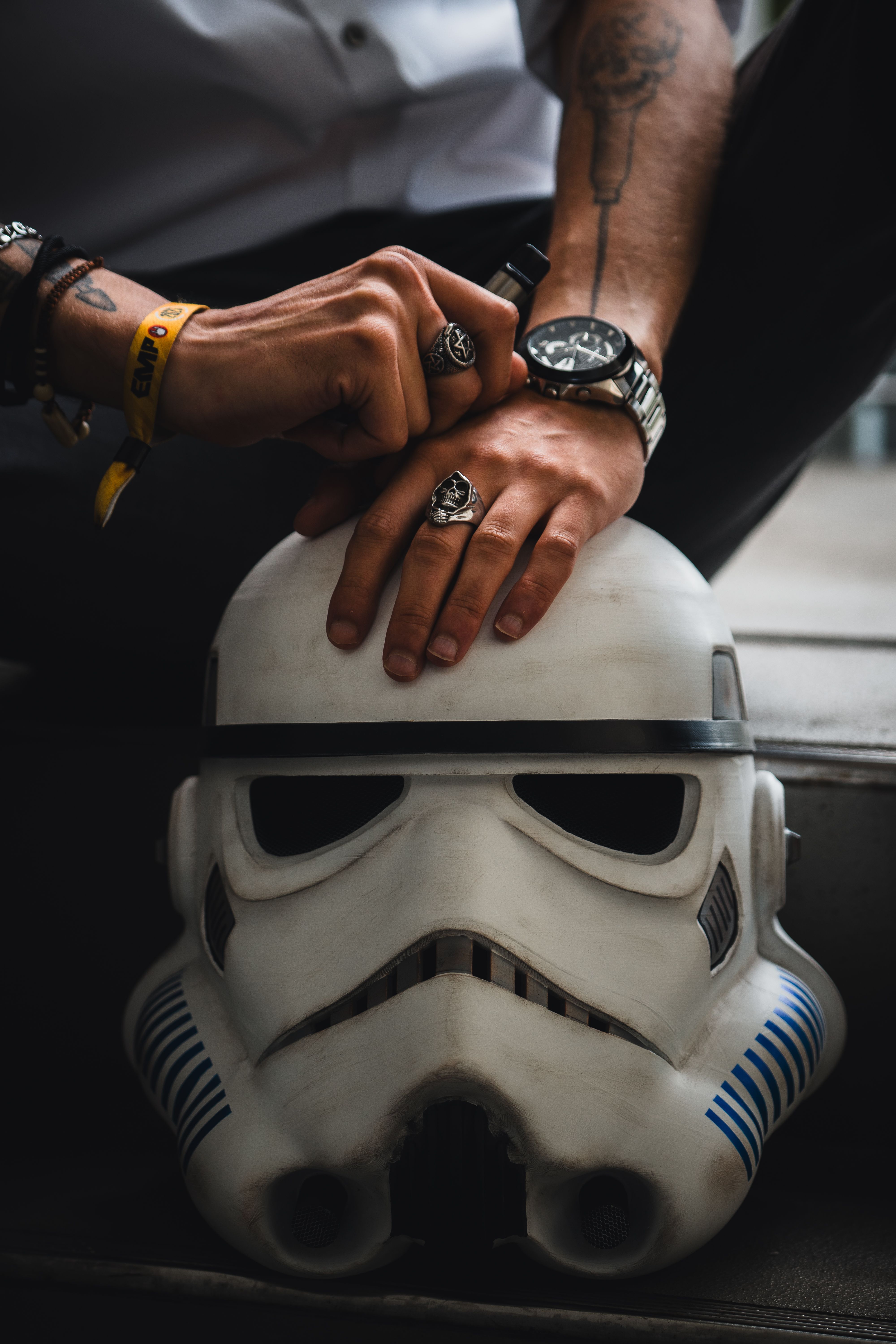 Hands Resting on Stormtrooper Helmet in Moody Lighting · Free Stock Photo
