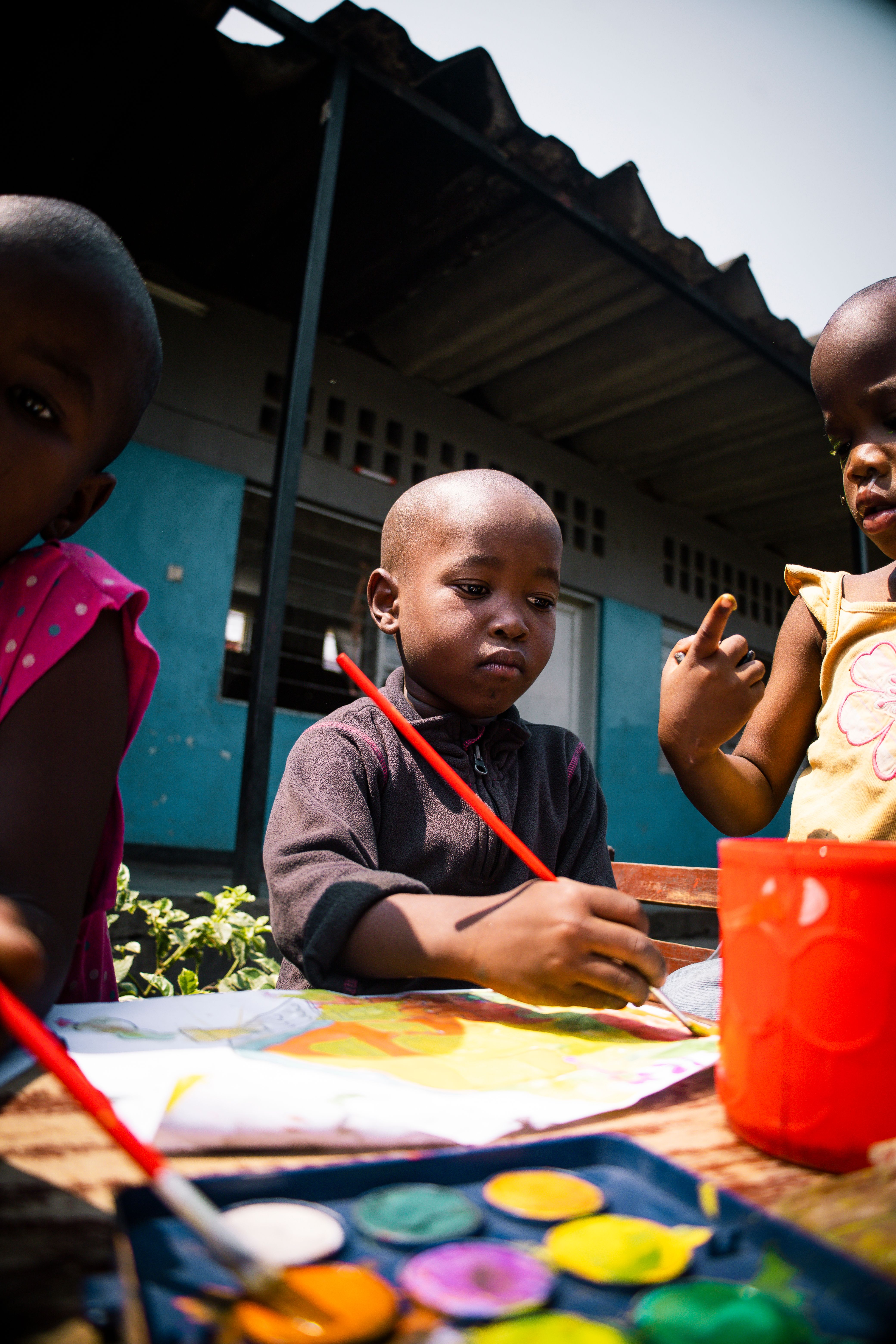 Children Painting Outdoors in Warm Sunlight · Free Stock Photo