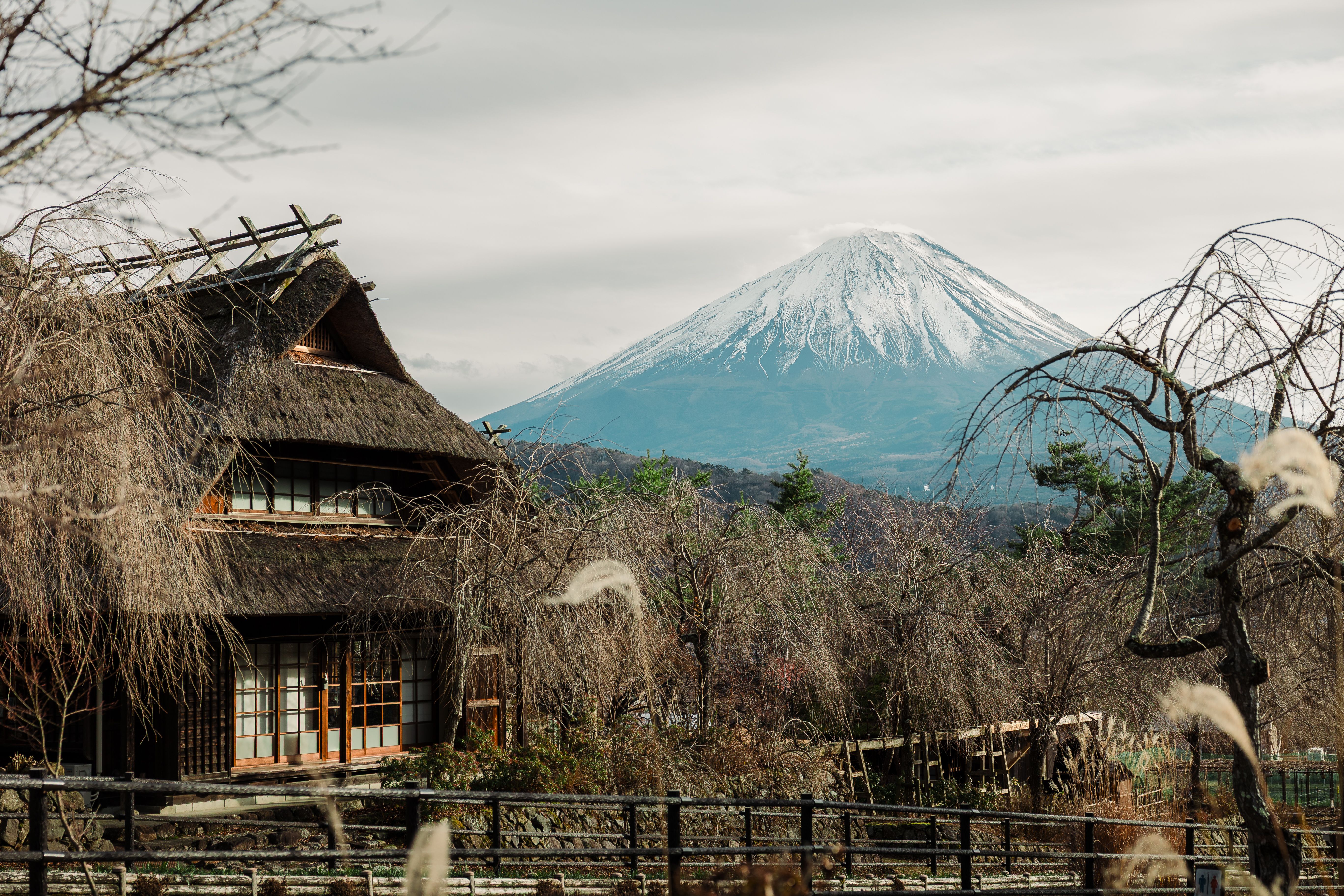 Gray Huts Near Snow-capped Mountain · Free Stock Photo