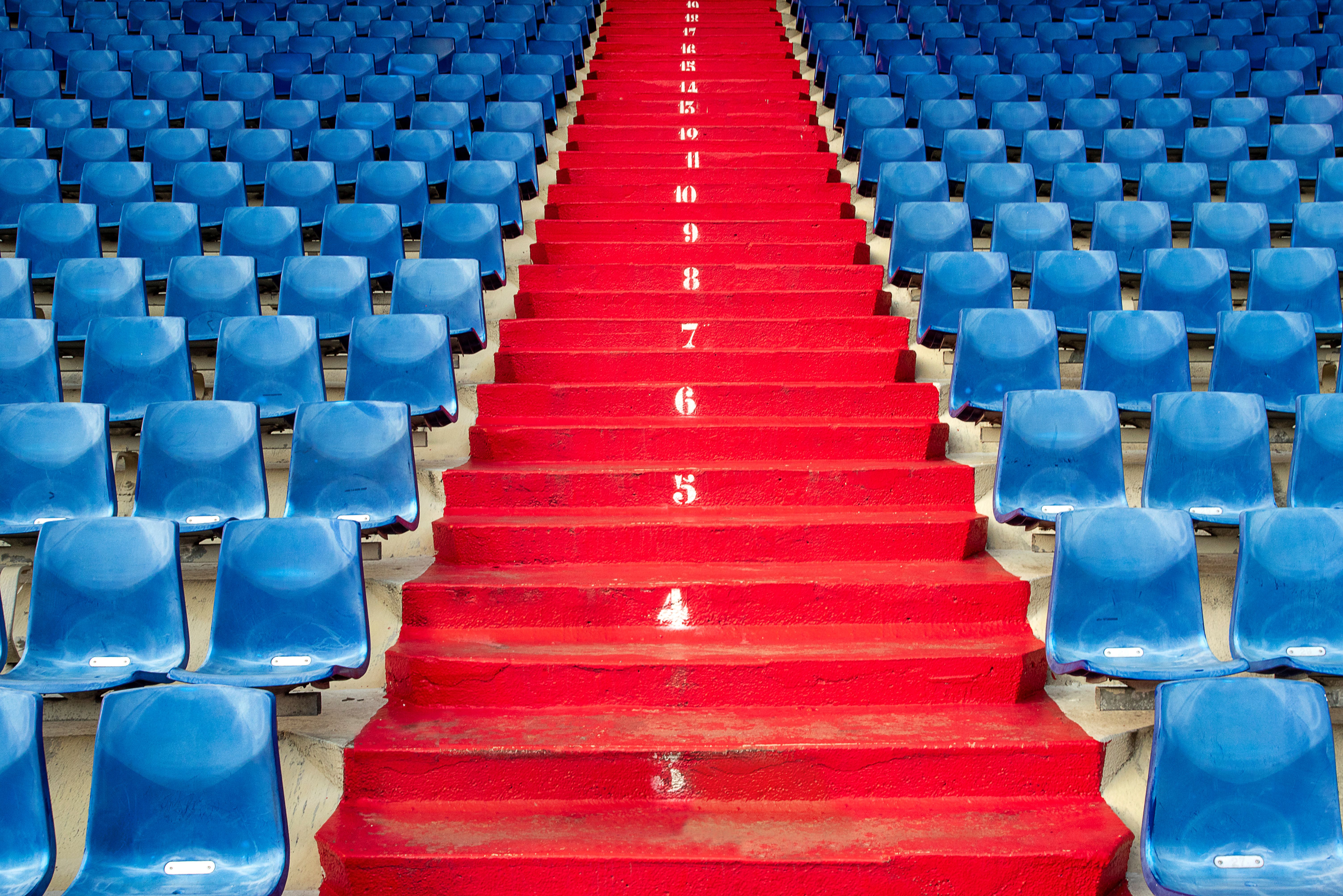 Vibrant Red Stairs and Blue Seats in Rotterdam Stadium · Free Stock Photo