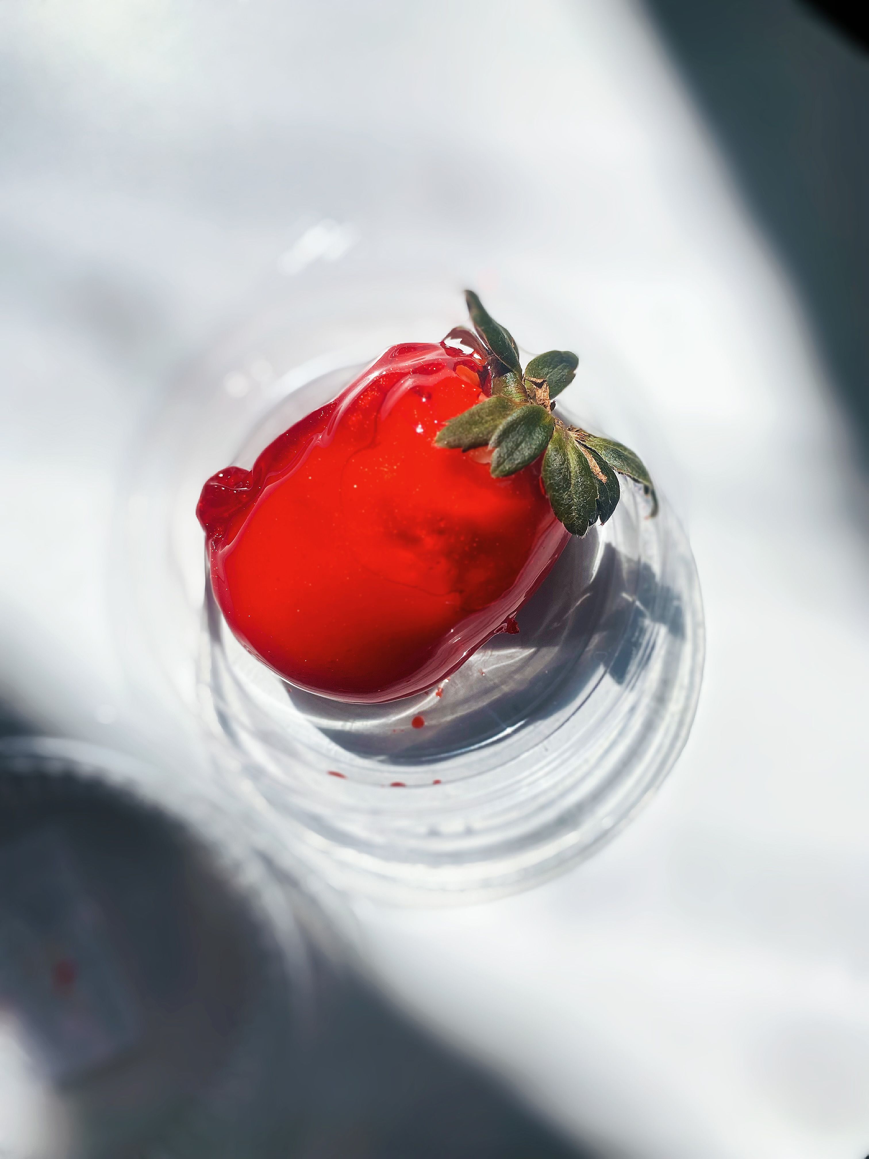 Close-Up of Strawberry in Glass with Shadow Play · Free Stock Photo