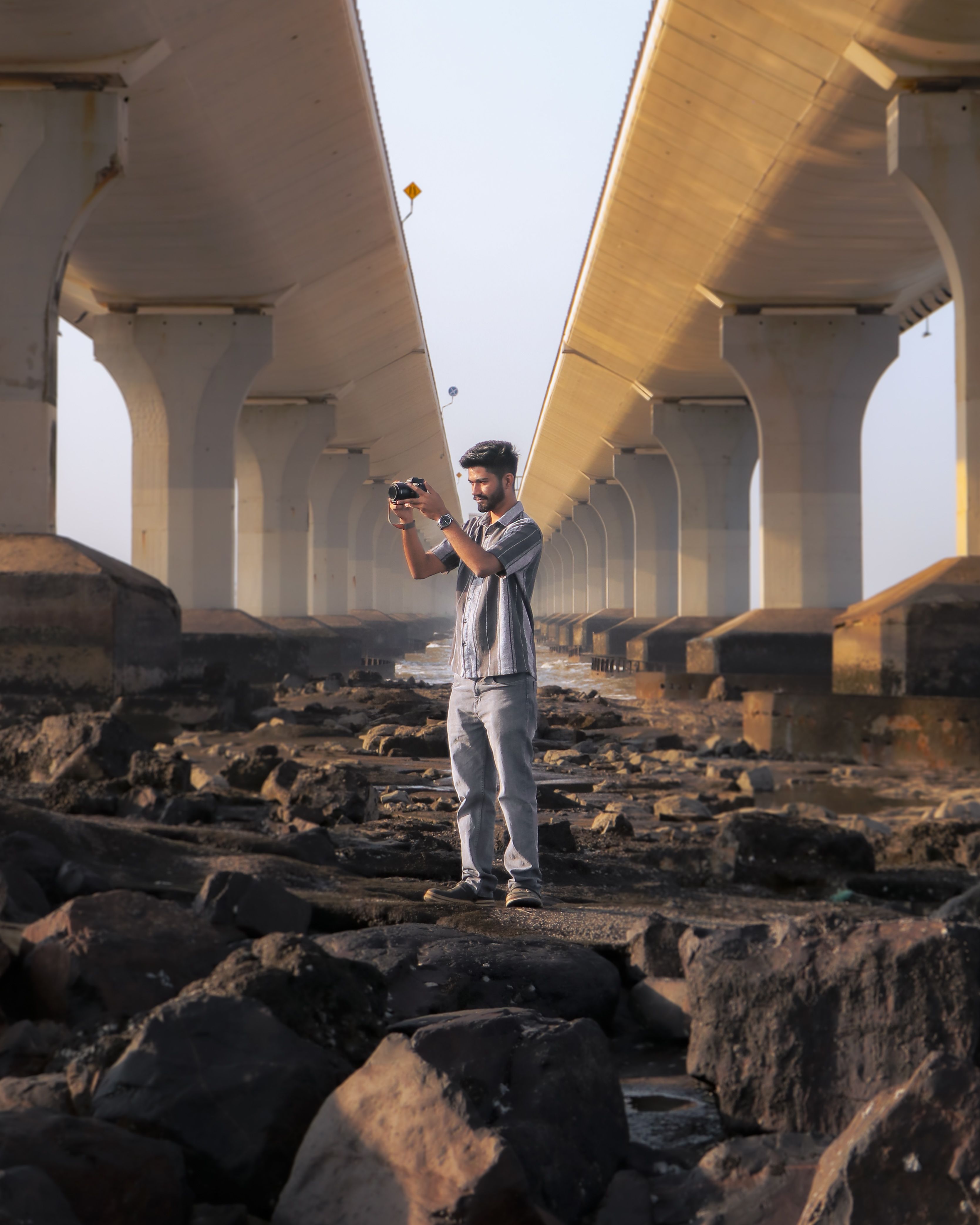 Man Photographing Under Bridge with Camera · Free Stock Photo