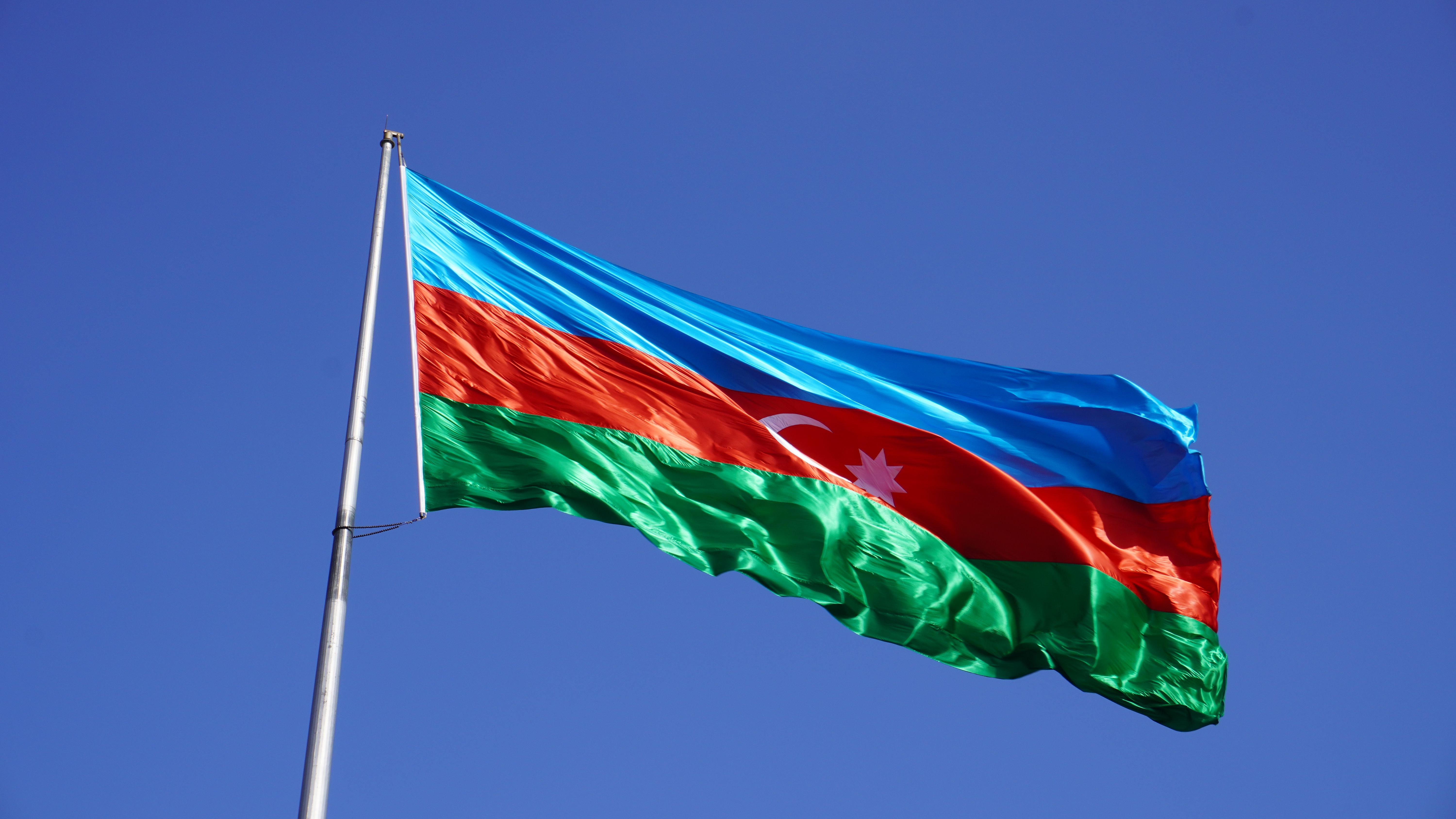 Azerbaijan National Flag Against Blue Sky · Free Stock Photo