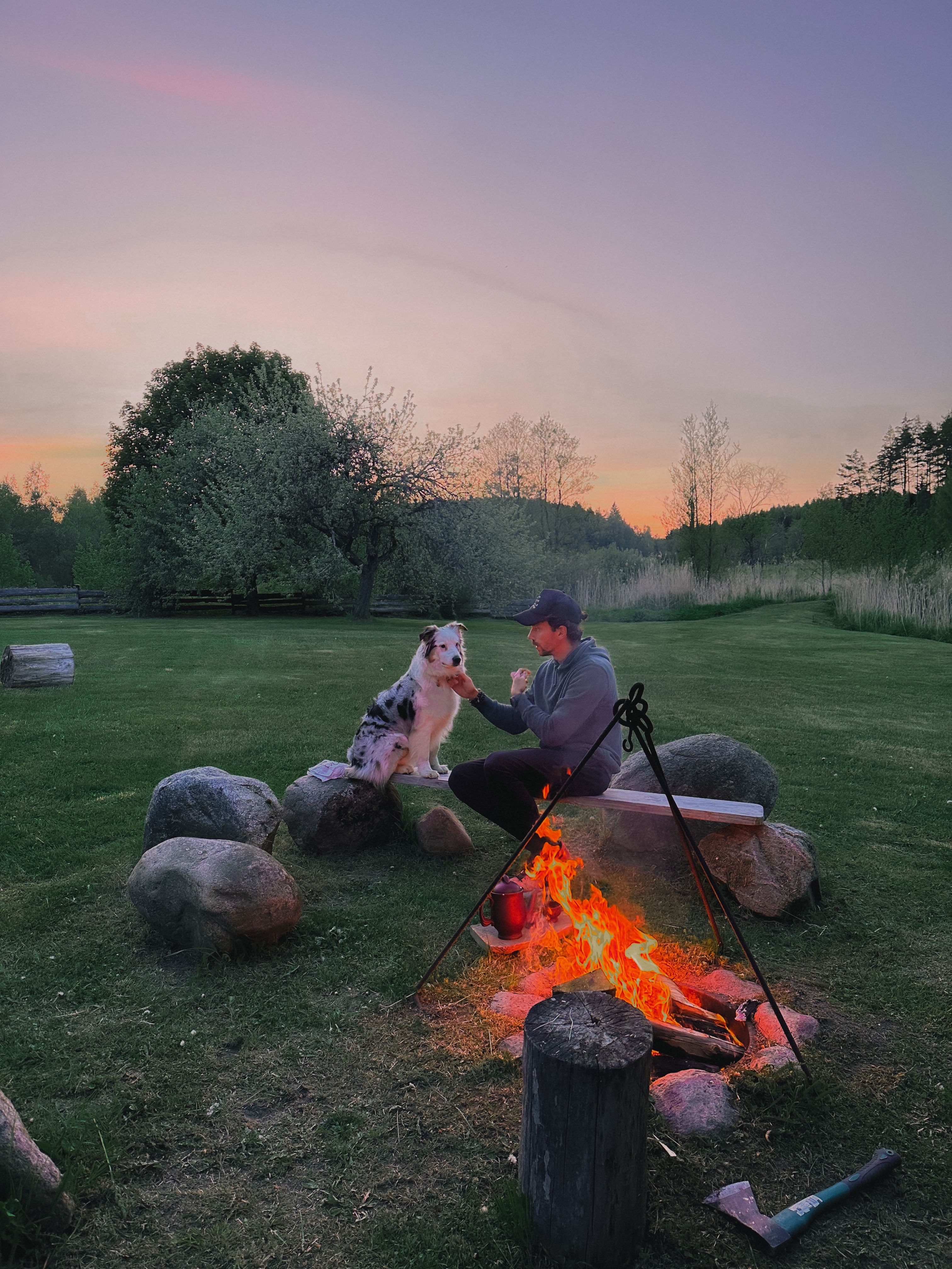 Man and Dog by Campfire at Twilight · Free Stock Photo