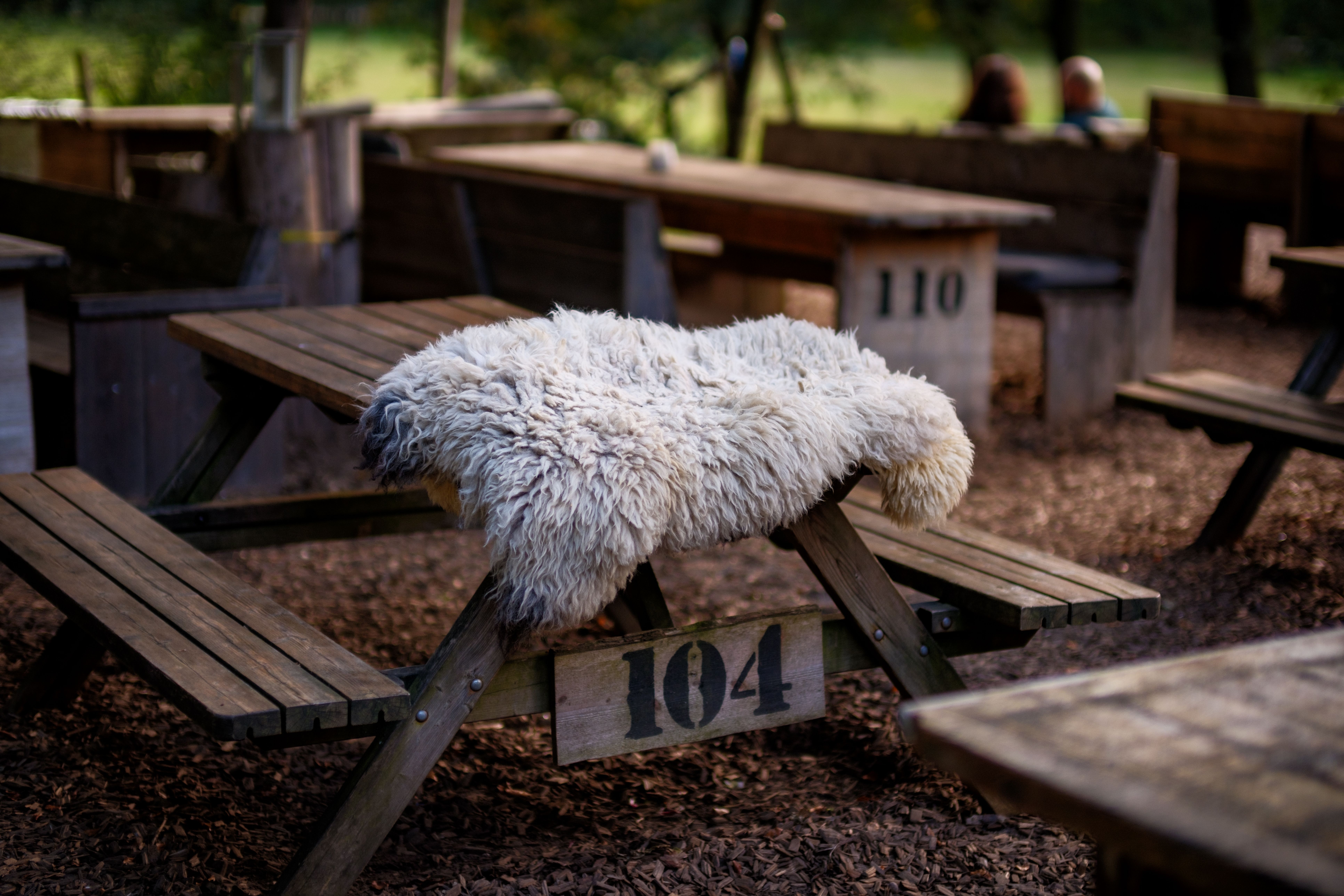 Rustic Outdoor Cafe with Sheepskin Decor · Free Stock Photo