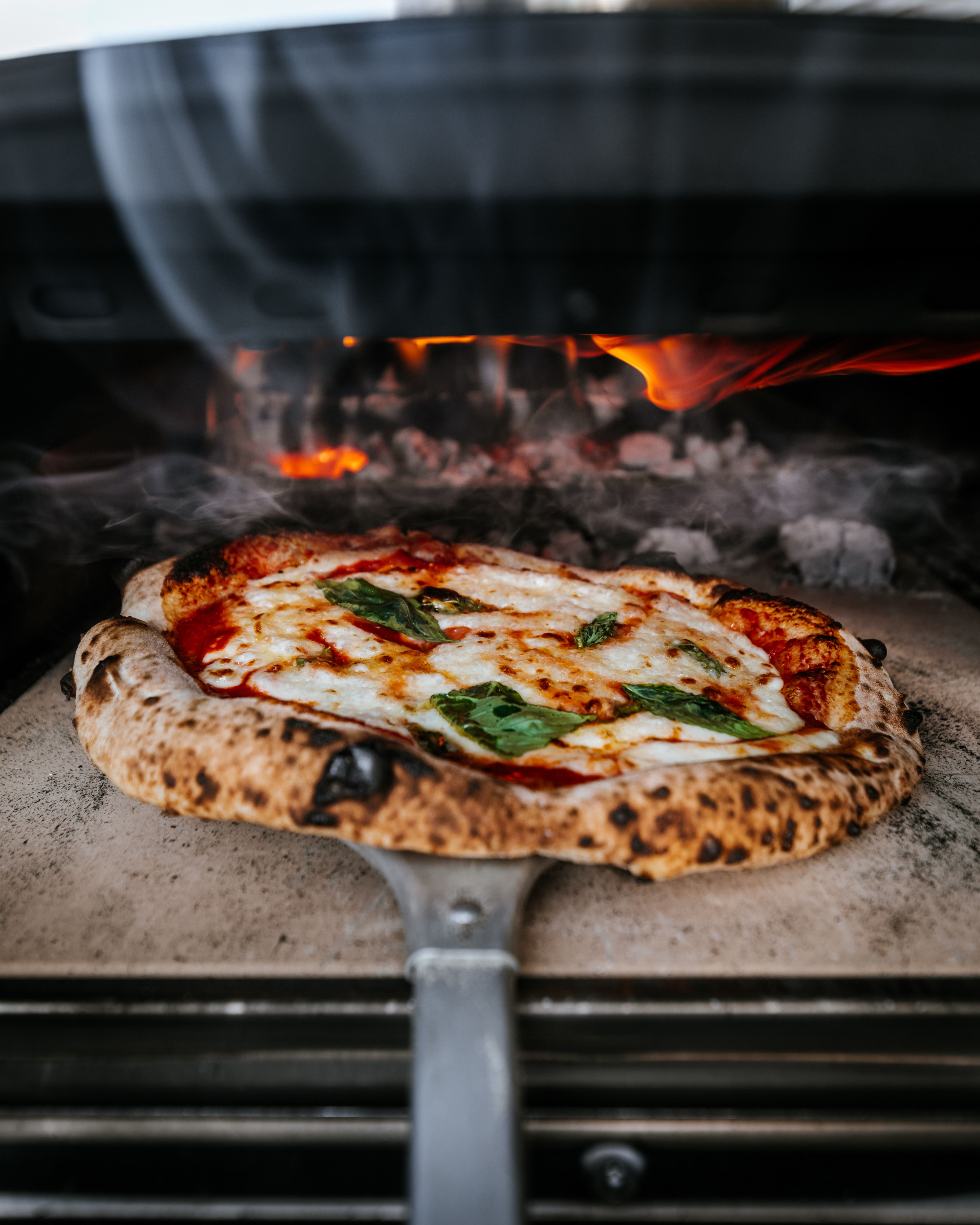 Authentic Italian Pizza in Wood-Fired Oven · Free Stock Photo