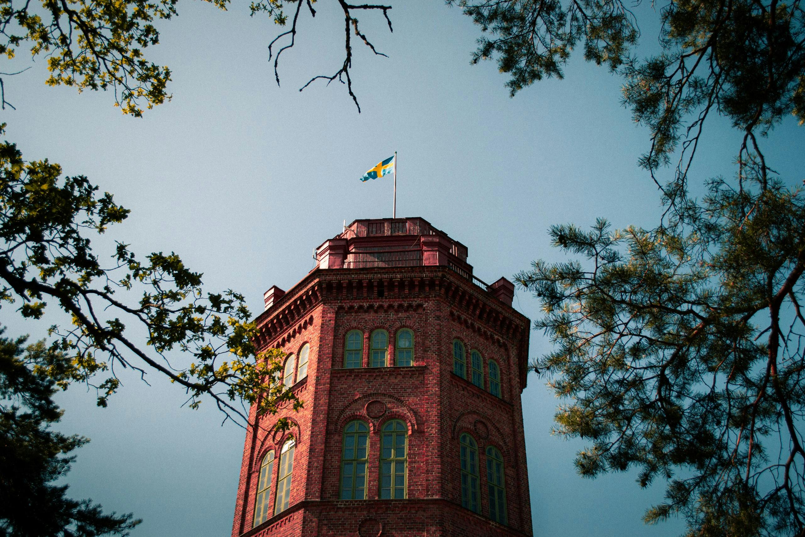 Historic Swedish Tower in Stockholm with Flag · Free Stock Photo