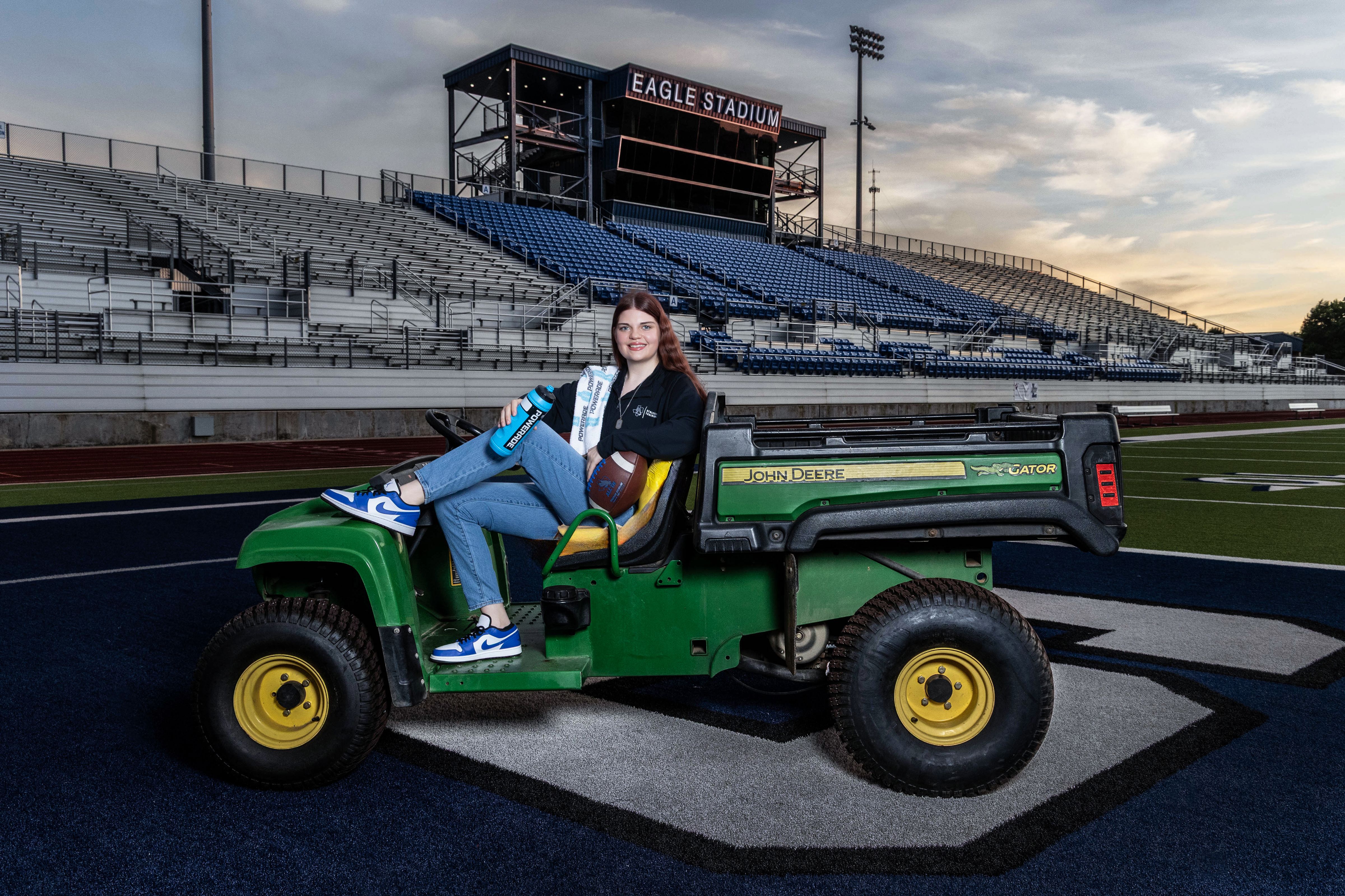 Teenager on Utility Vehicle at Stadium · Free Stock Photo