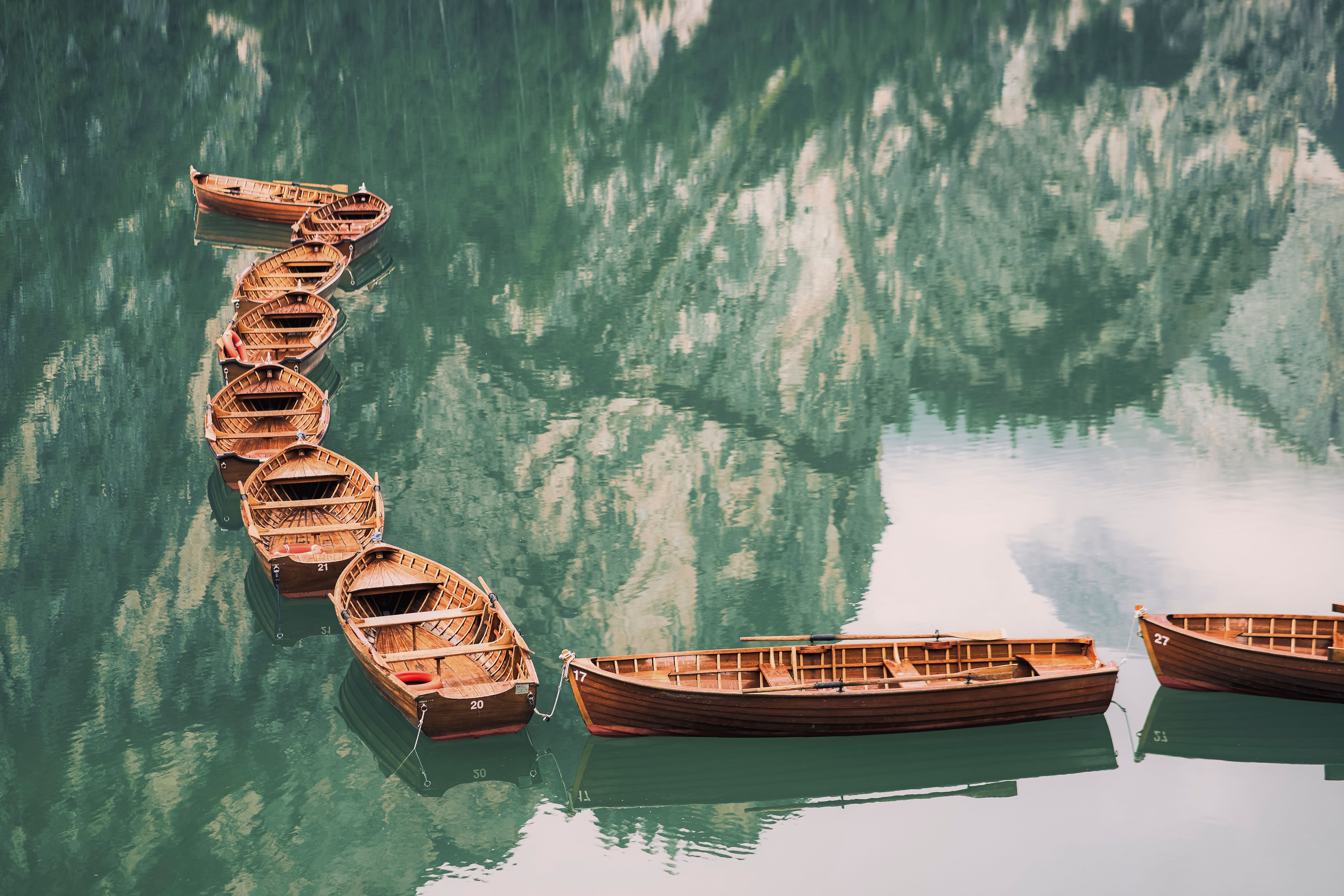 Rowboats on Serene Lake with Mountain Reflection · Free Stock Photo