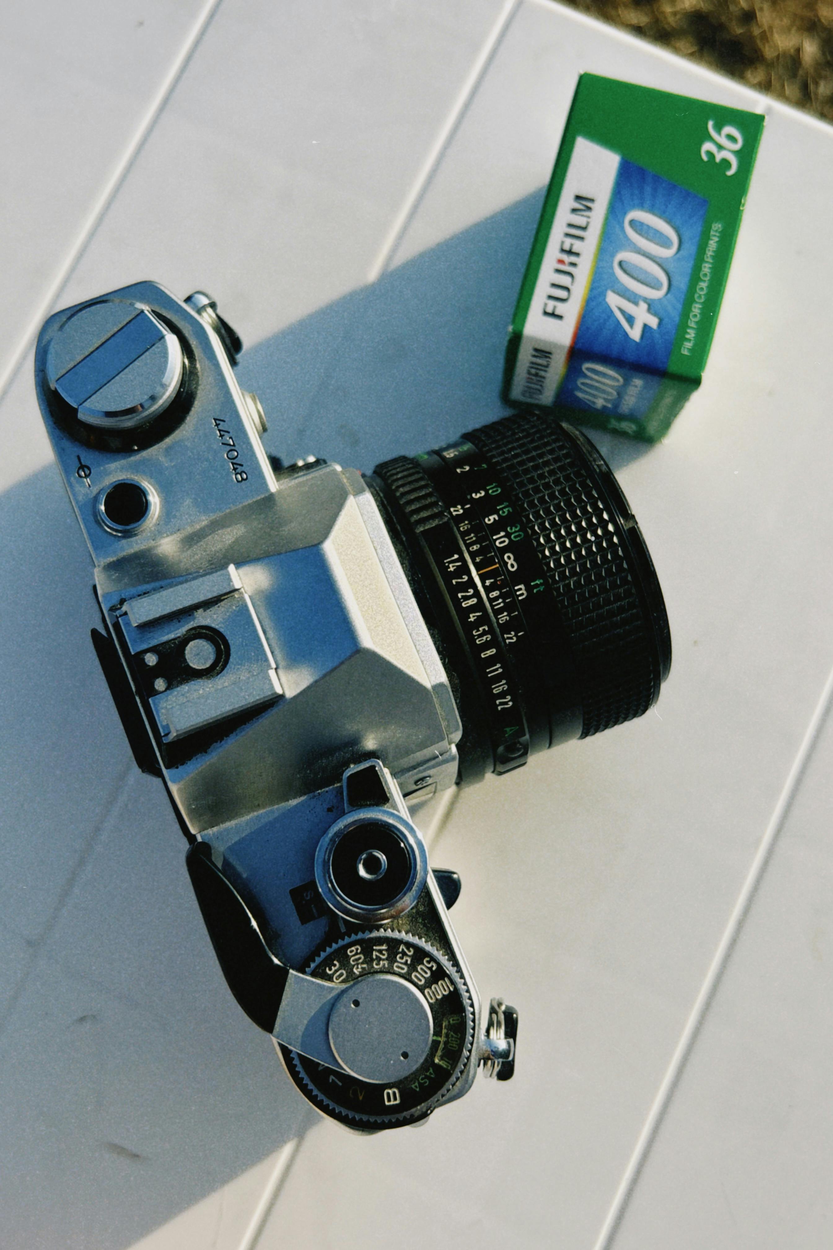 Vintage Camera with Fujifilm Roll on Table · Free Stock Photo