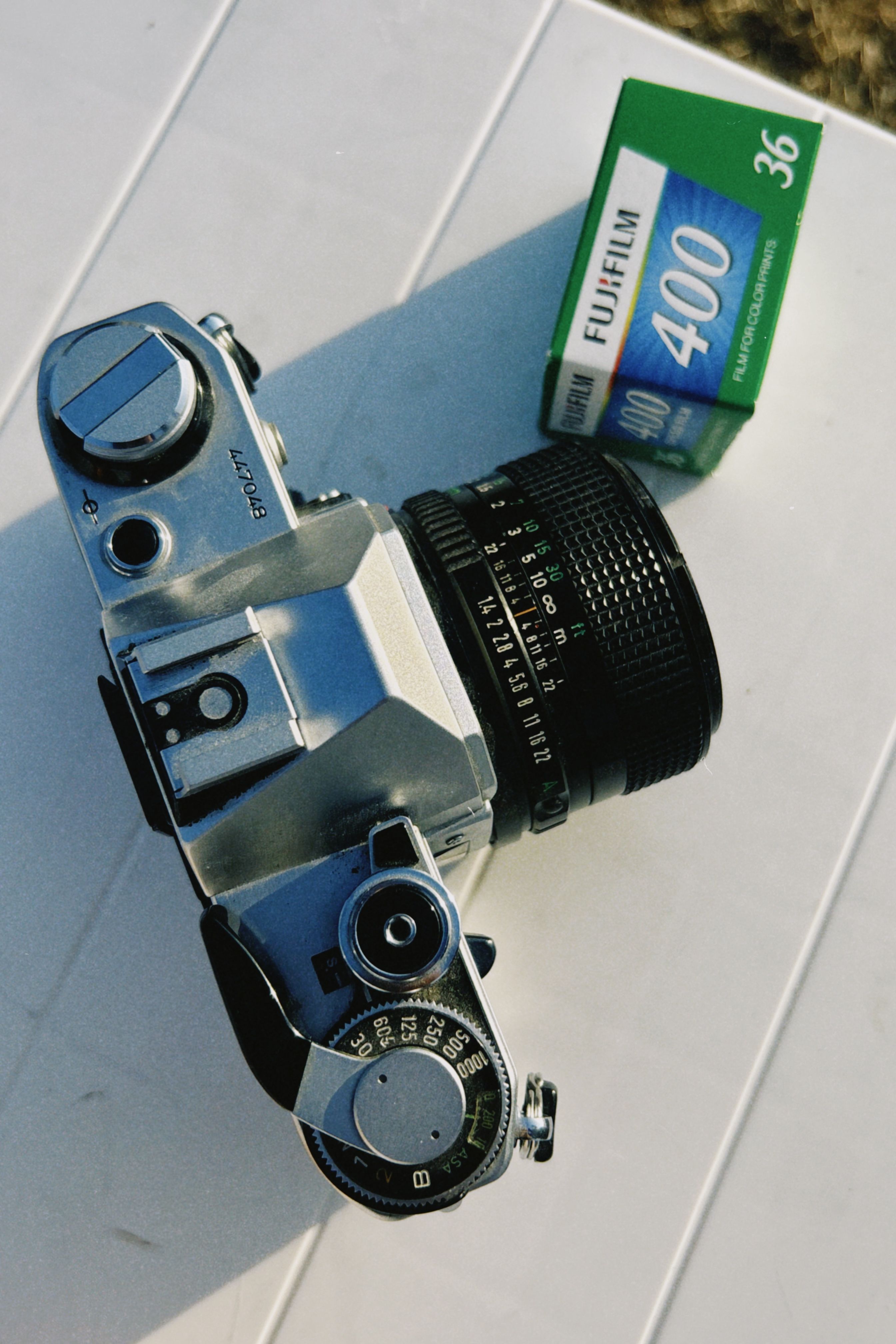 Vintage Camera with Fujifilm Roll on Table · Free Stock Photo