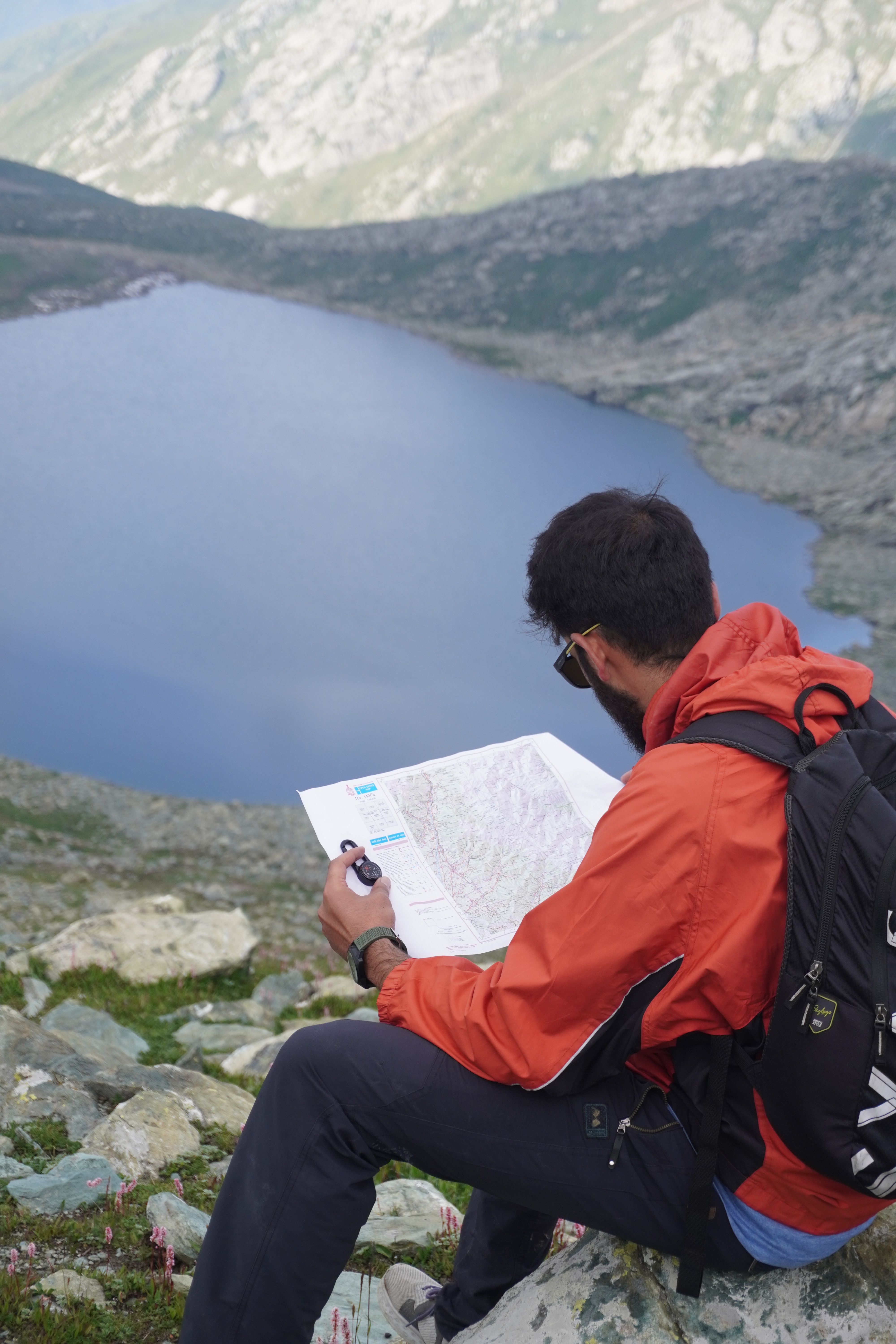 Hiker Navigating Mountain Trails with Map · Free Stock Photo
