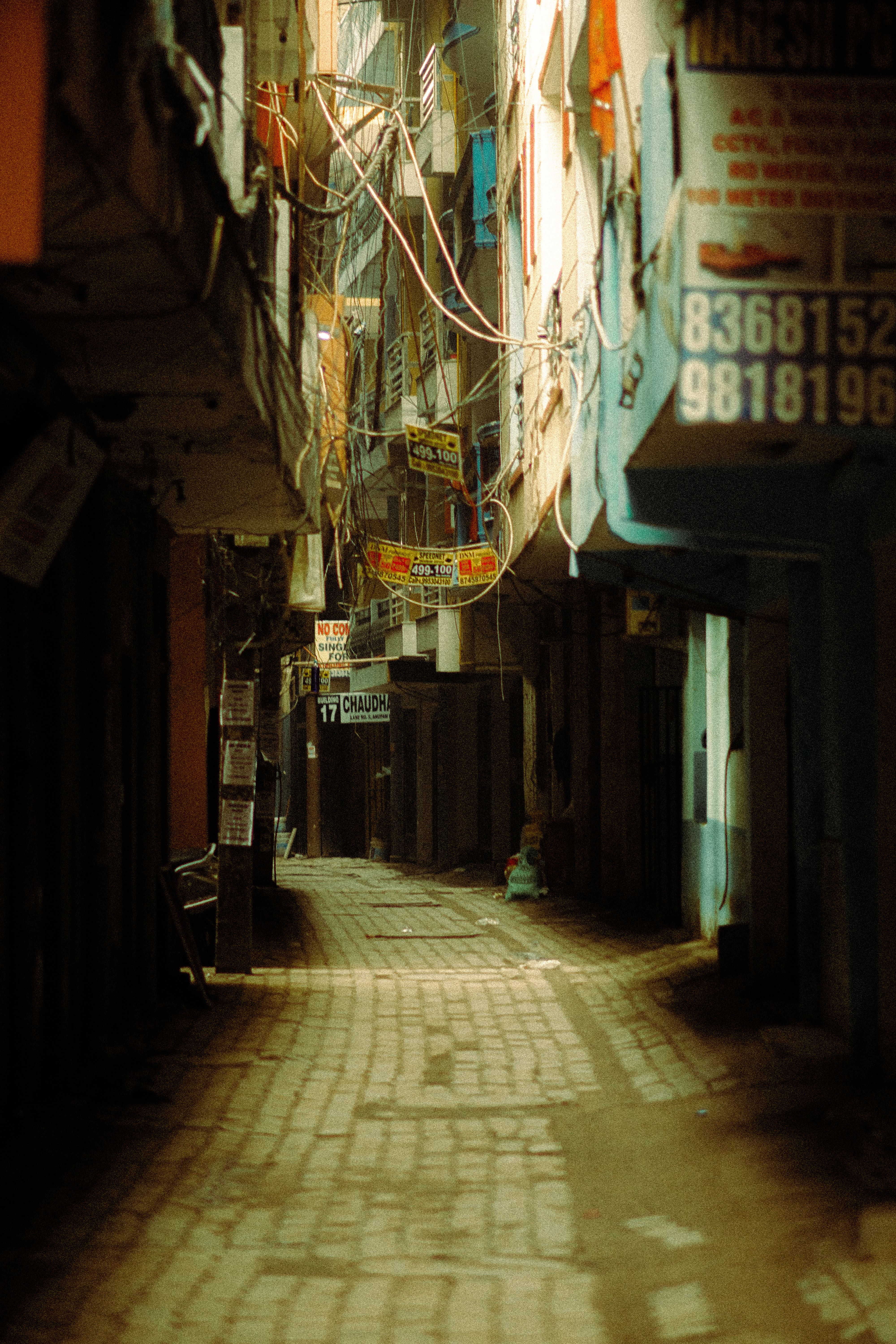 Narrow Alley in Urban Area with Colorful Signage · Free Stock Photo