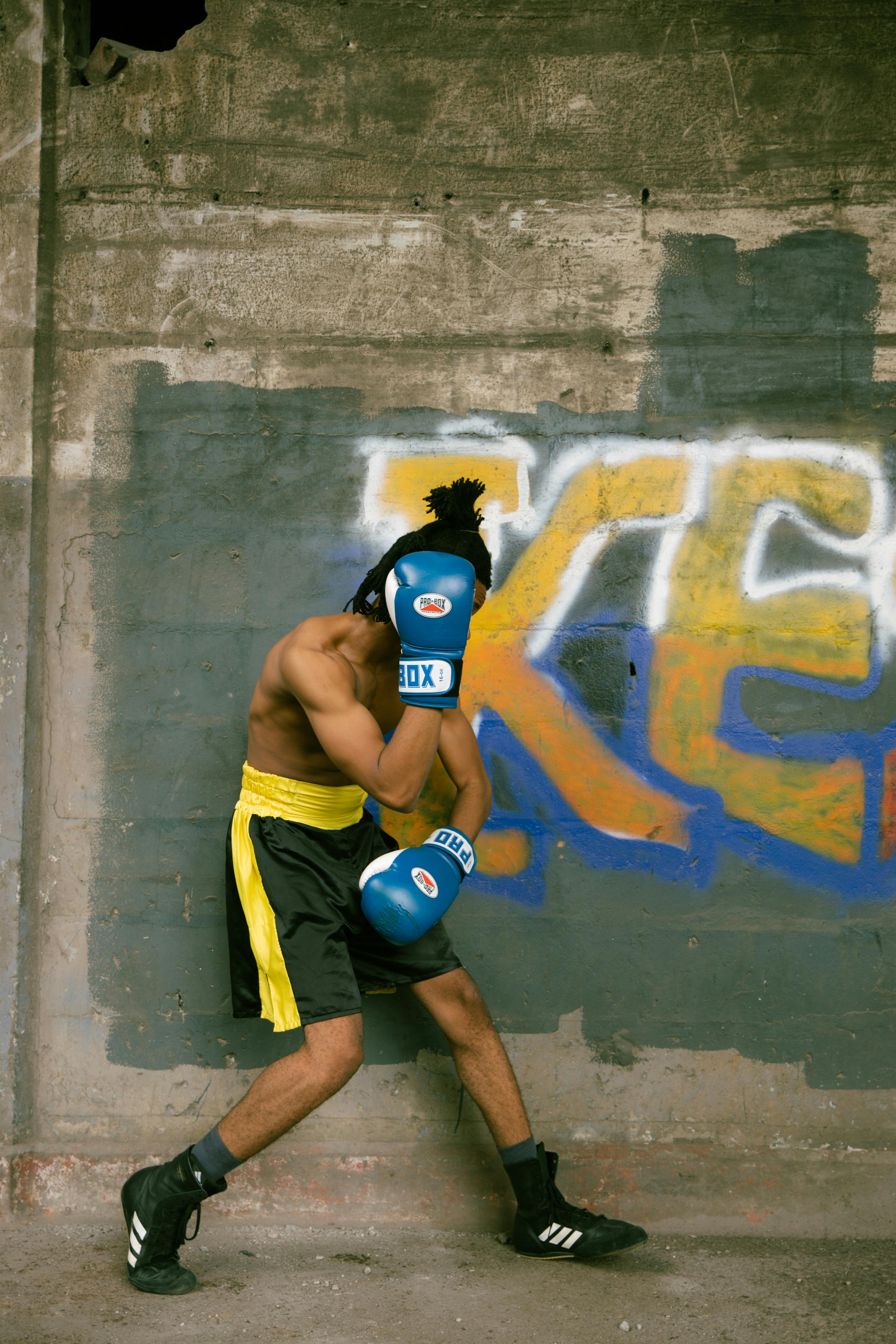 Boxer Training Indoors with Graffiti Background · Free Stock Photo