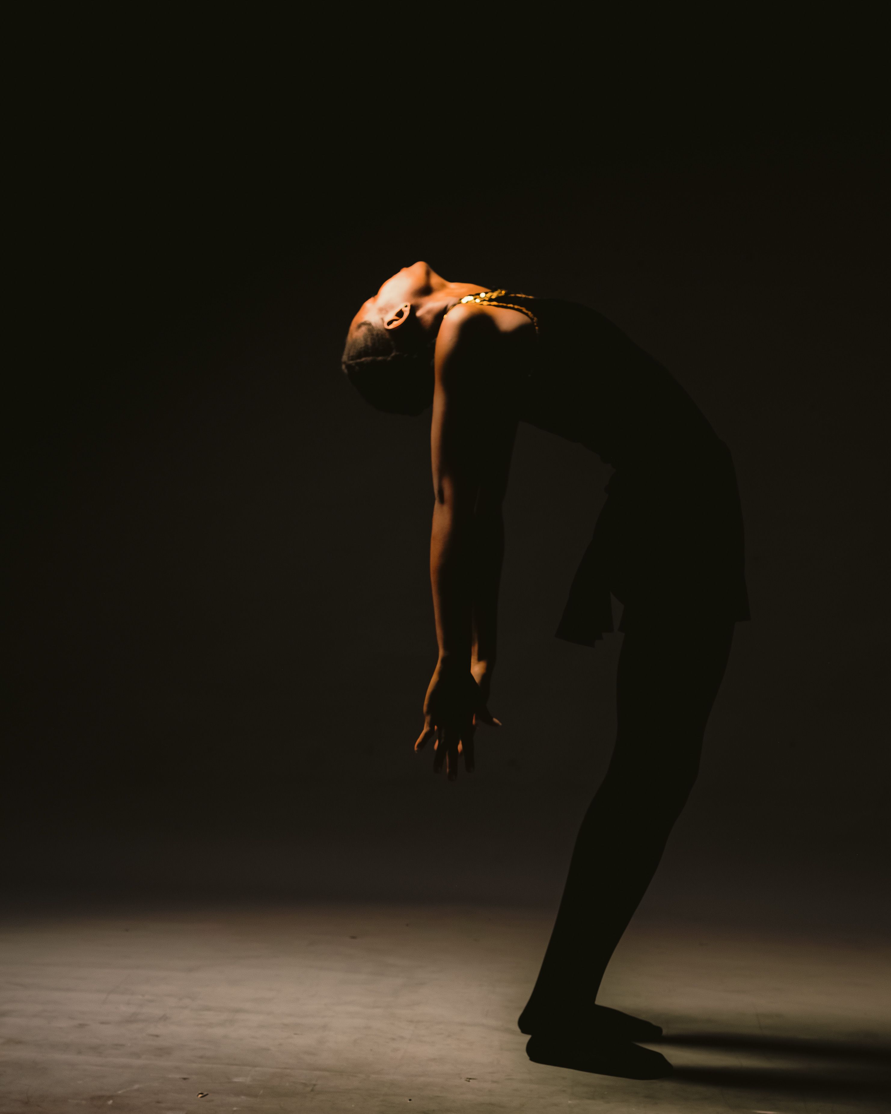 Dramatic Dance Pose with Artistic Lighting · Free Stock Photo