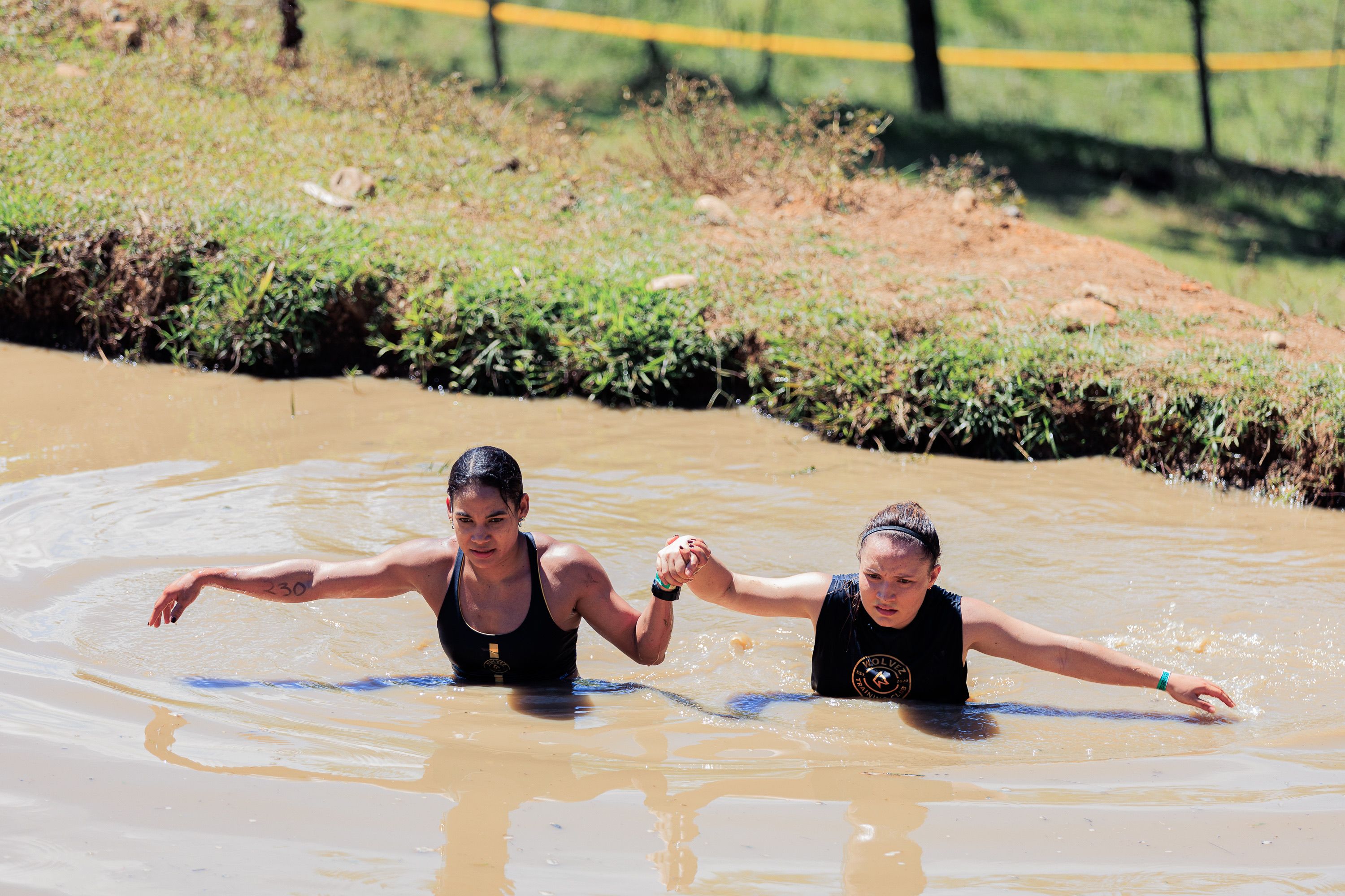 Women Participating in Muddy Obstacle Course Race · Free Stock Photo