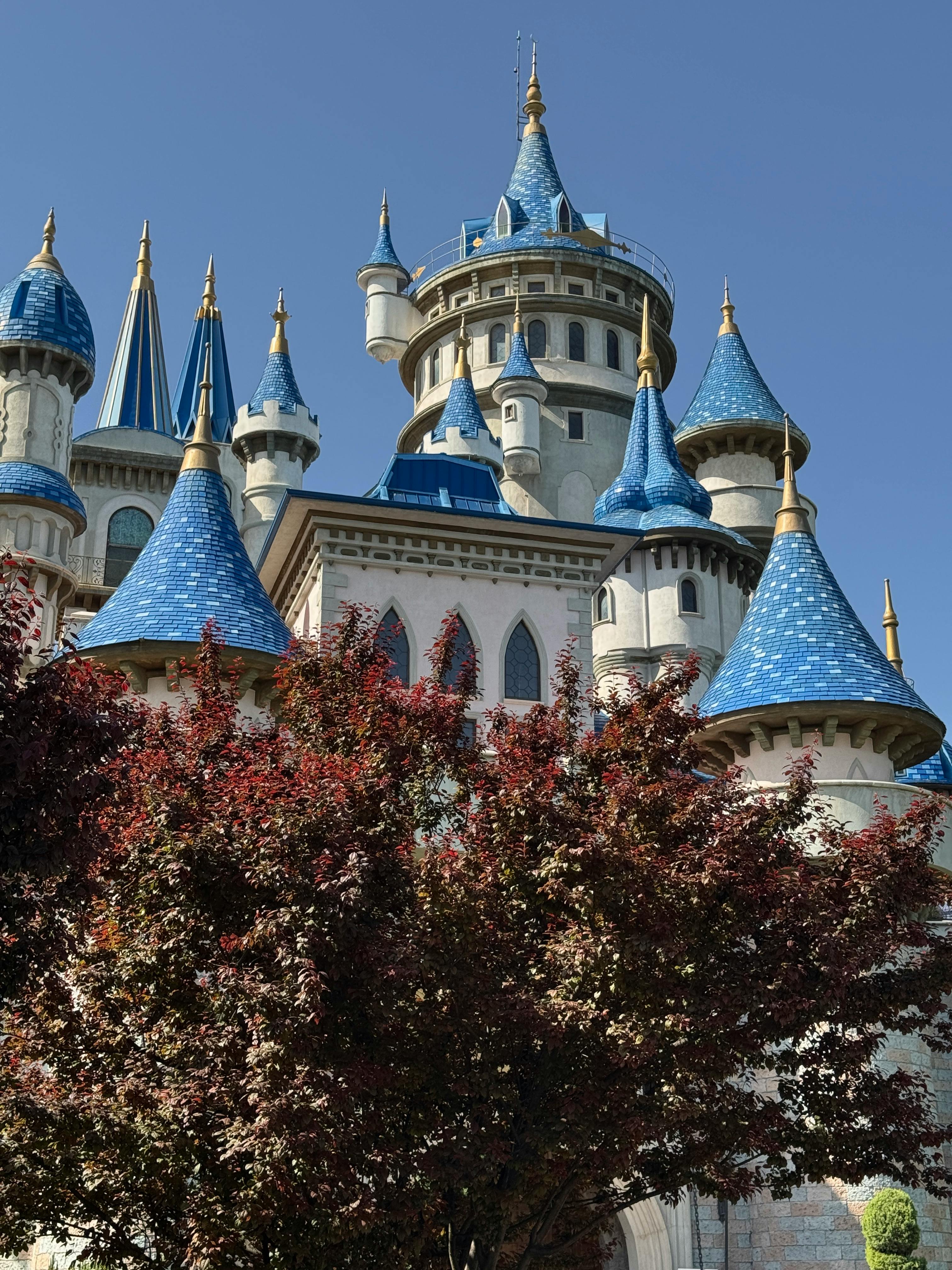 Majestic Blue Roof Castle Against Clear Sky · Free Stock Photo