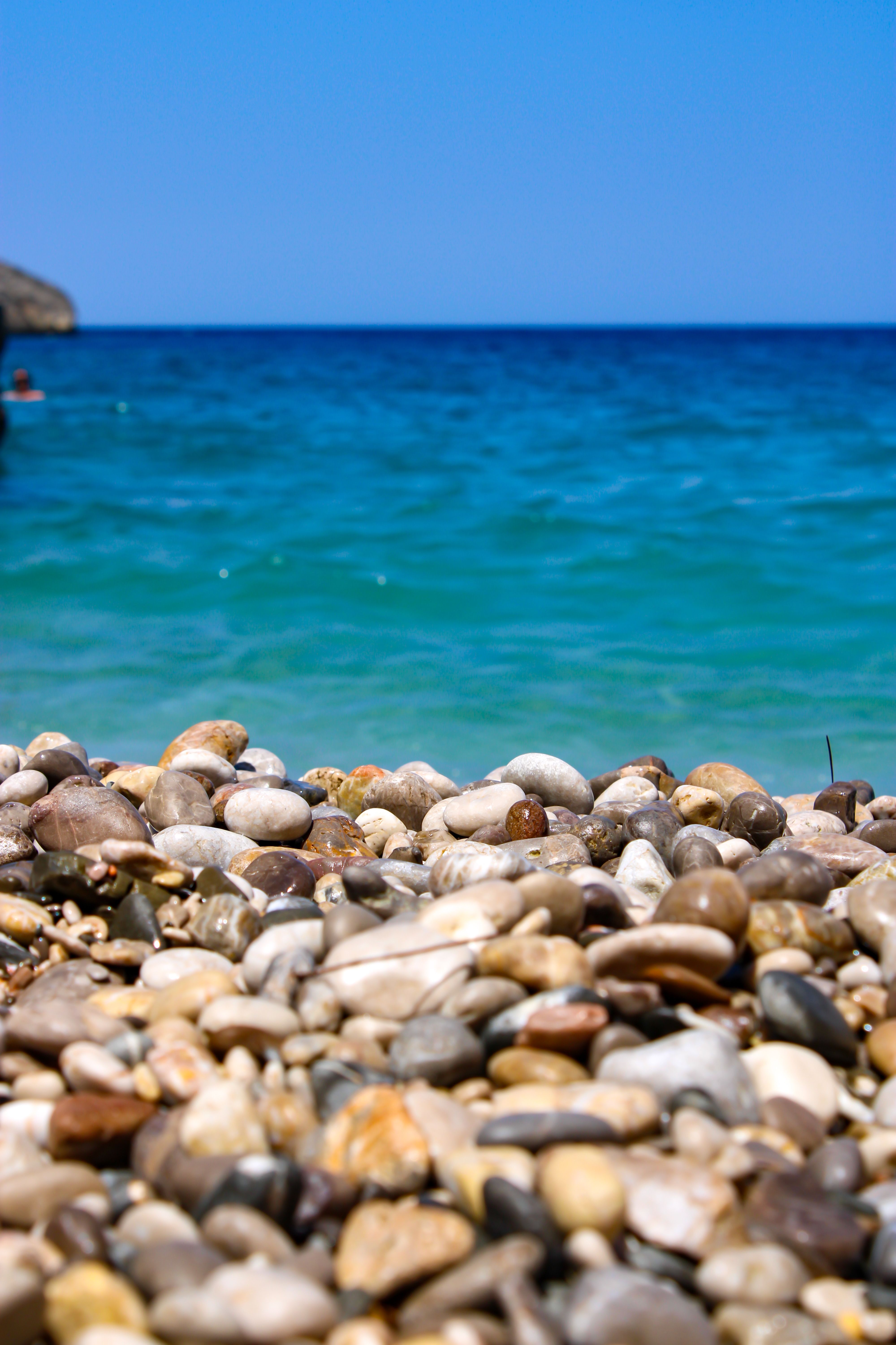 Pebble Beach with Clear Blue Sea in Summer · Free Stock Photo