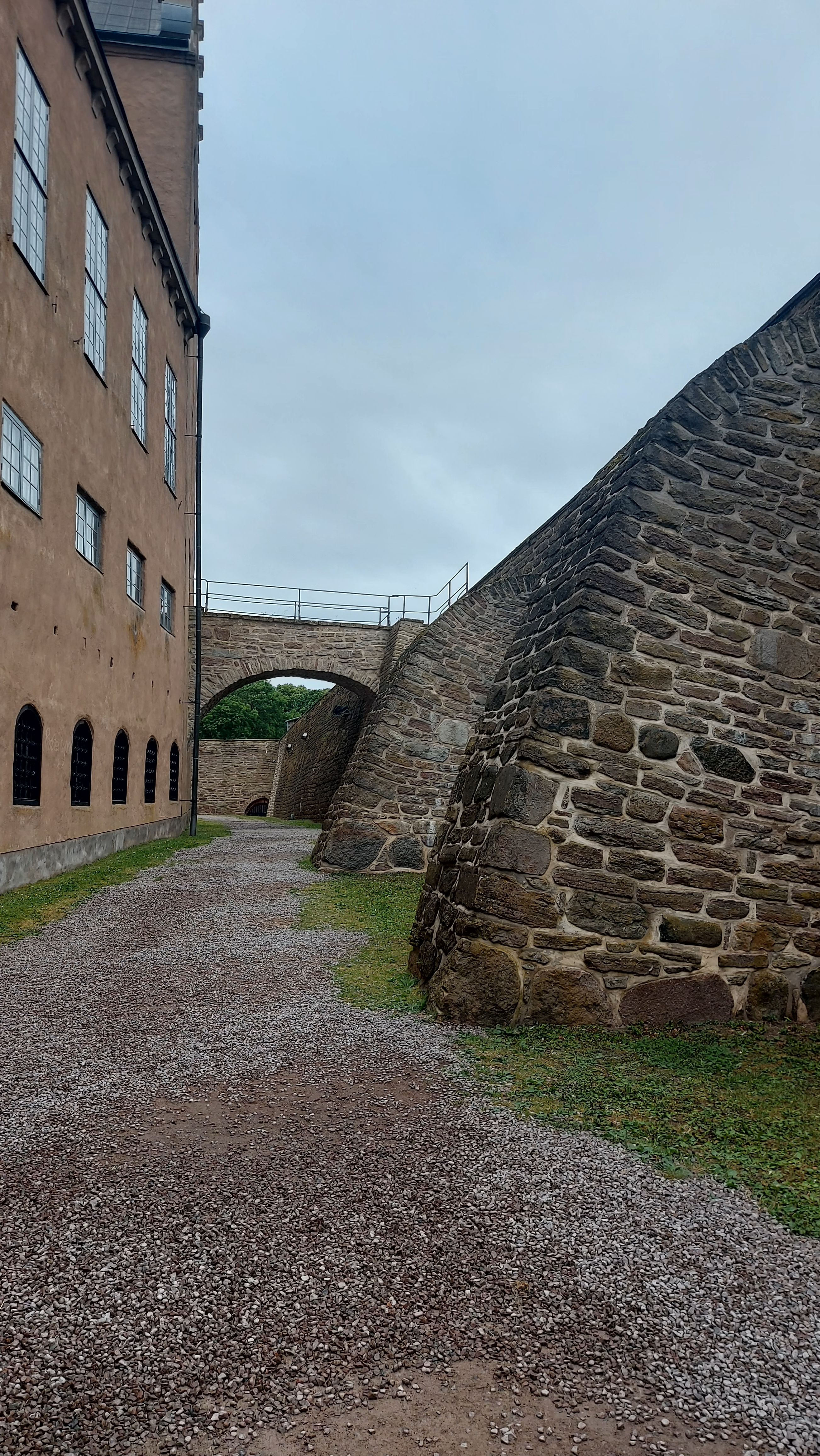 Historic Stone Castle Pathway Under Cloudy Sky · Free Stock Photo