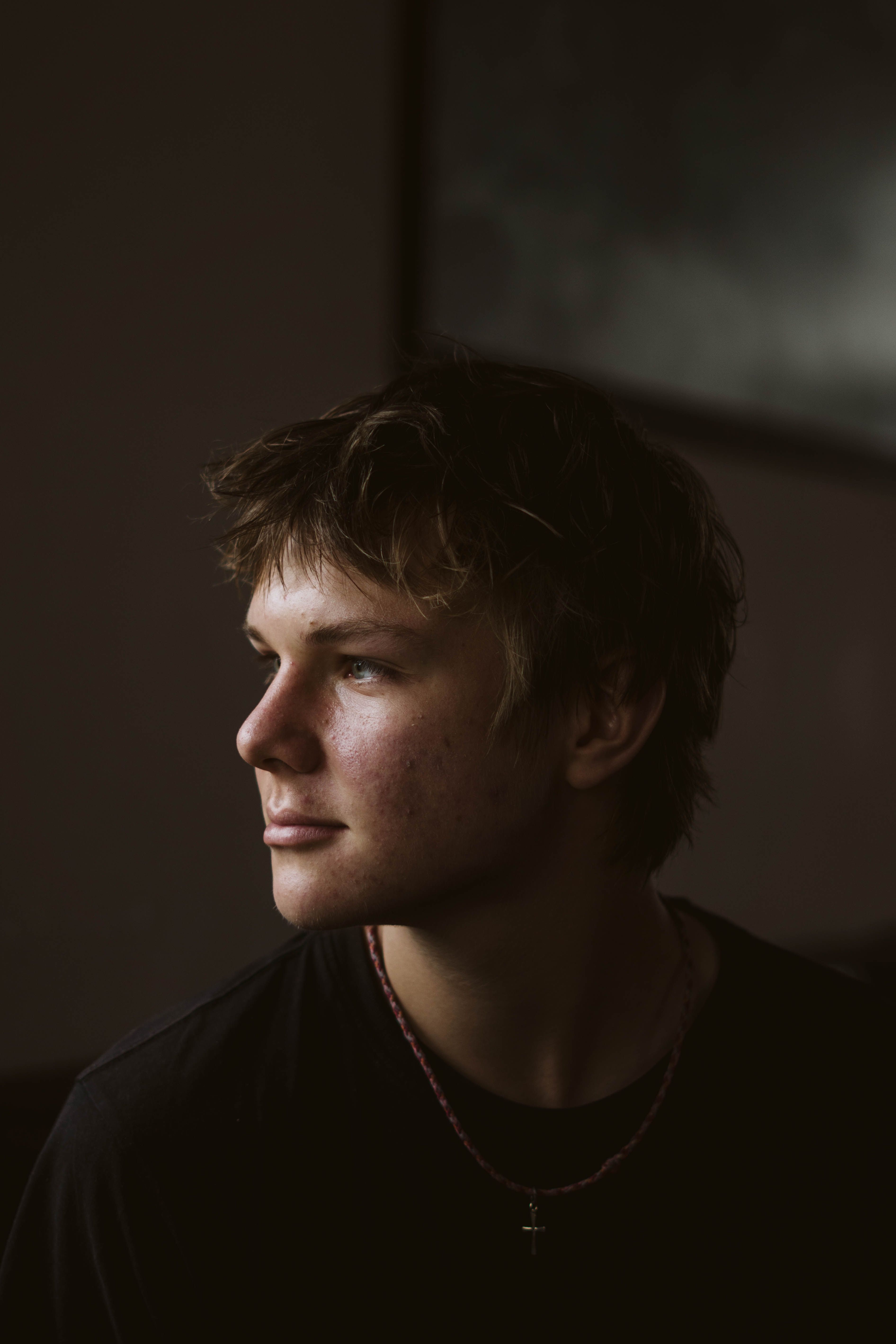 Pensive Young Man in Moody Lighting Portrait · Free Stock Photo
