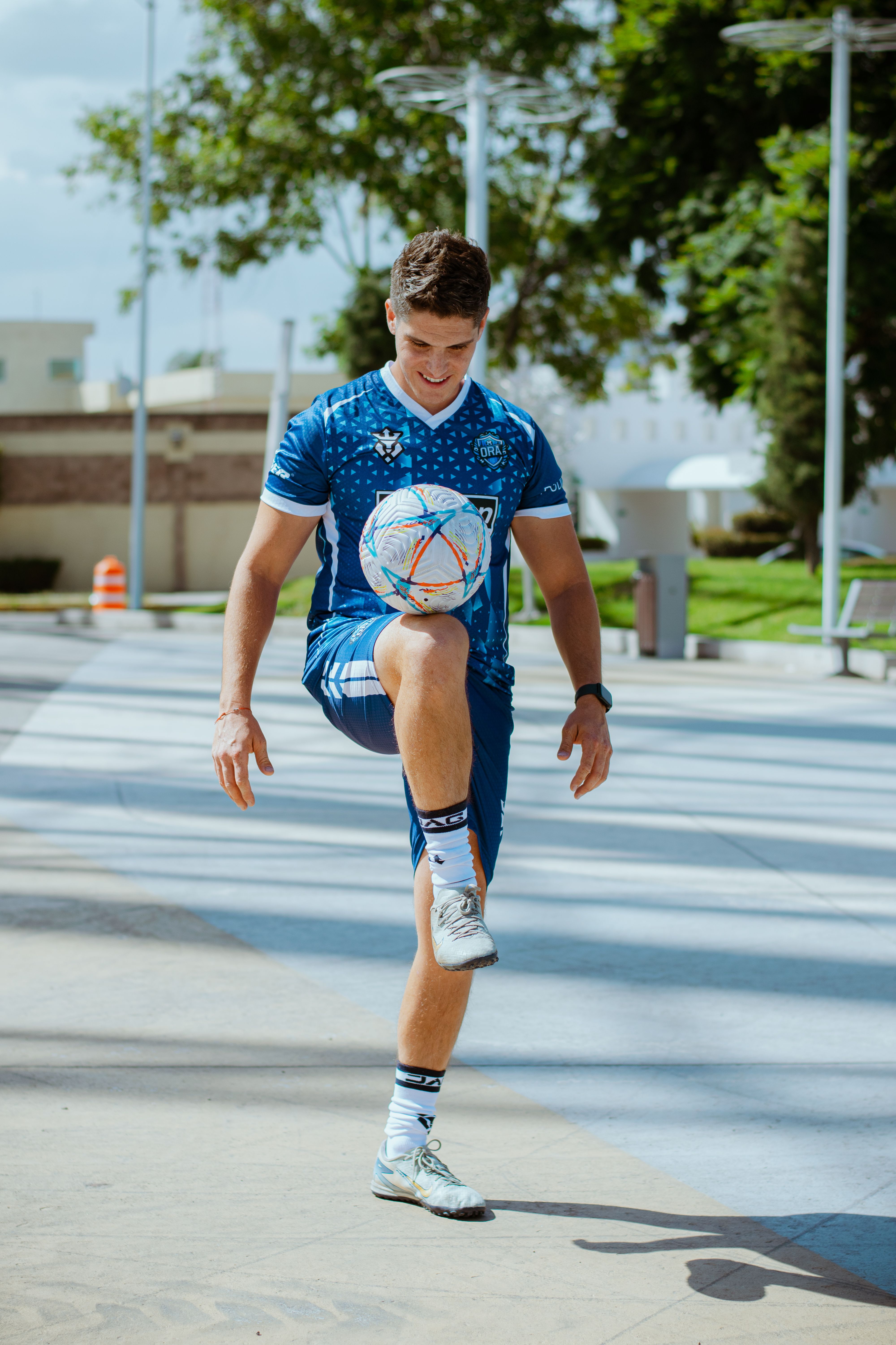 Young Man Juggling Soccer Ball in Urban Park · Free Stock Photo