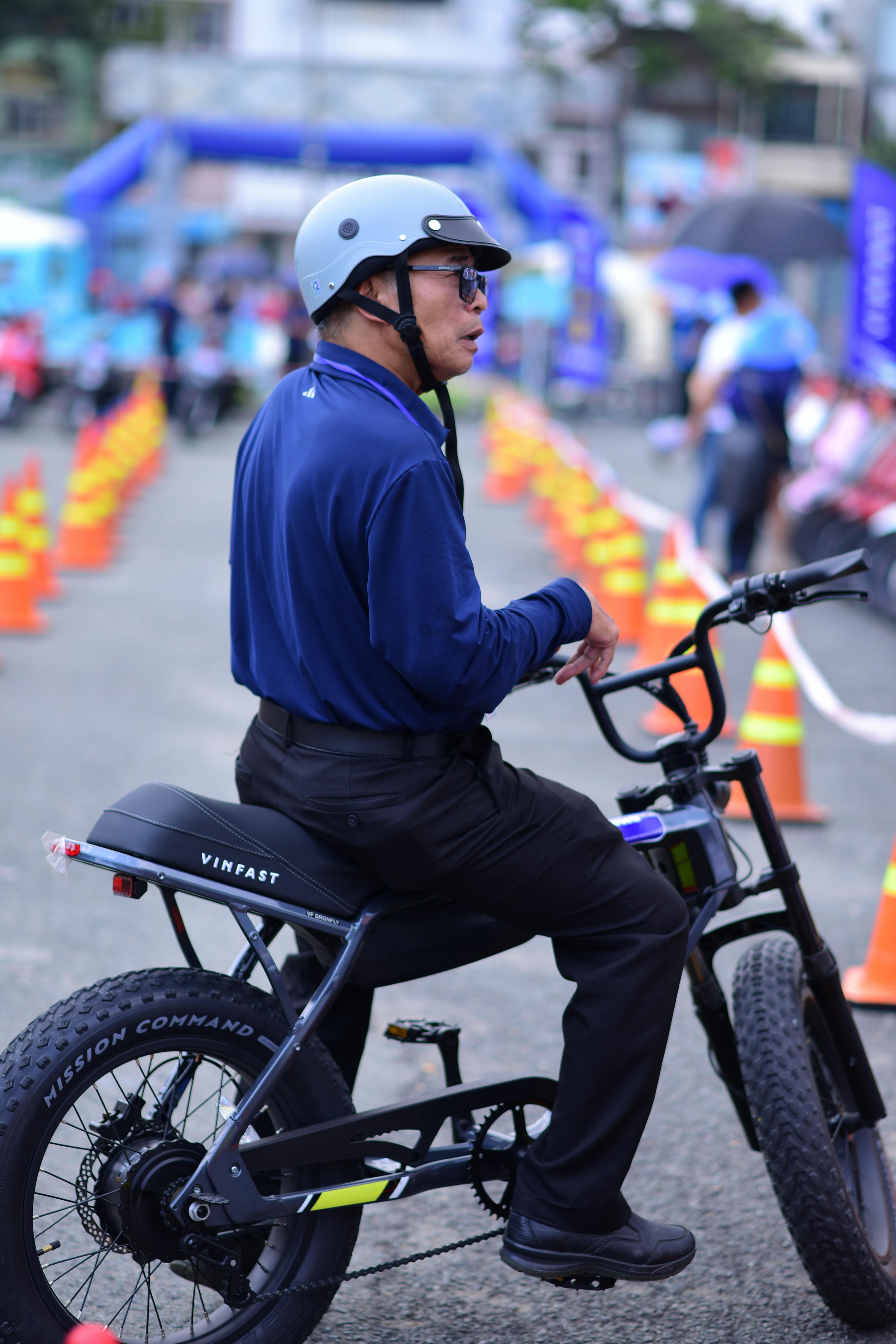 Man Riding Electric Bicycle at Outdoor Event · Free Stock Photo