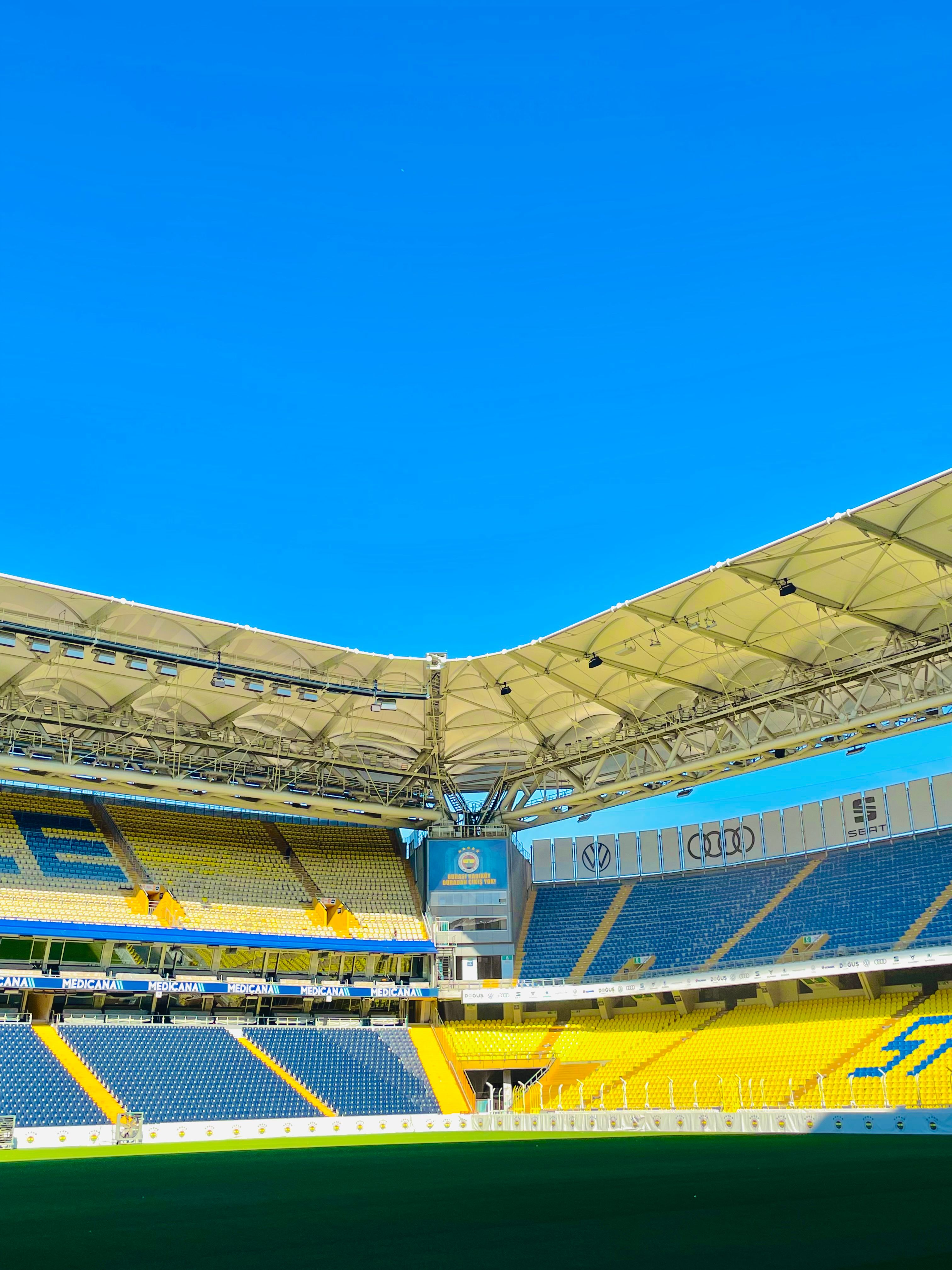 Vibrant Blue and Yellow Stadium Interior · Free Stock Photo