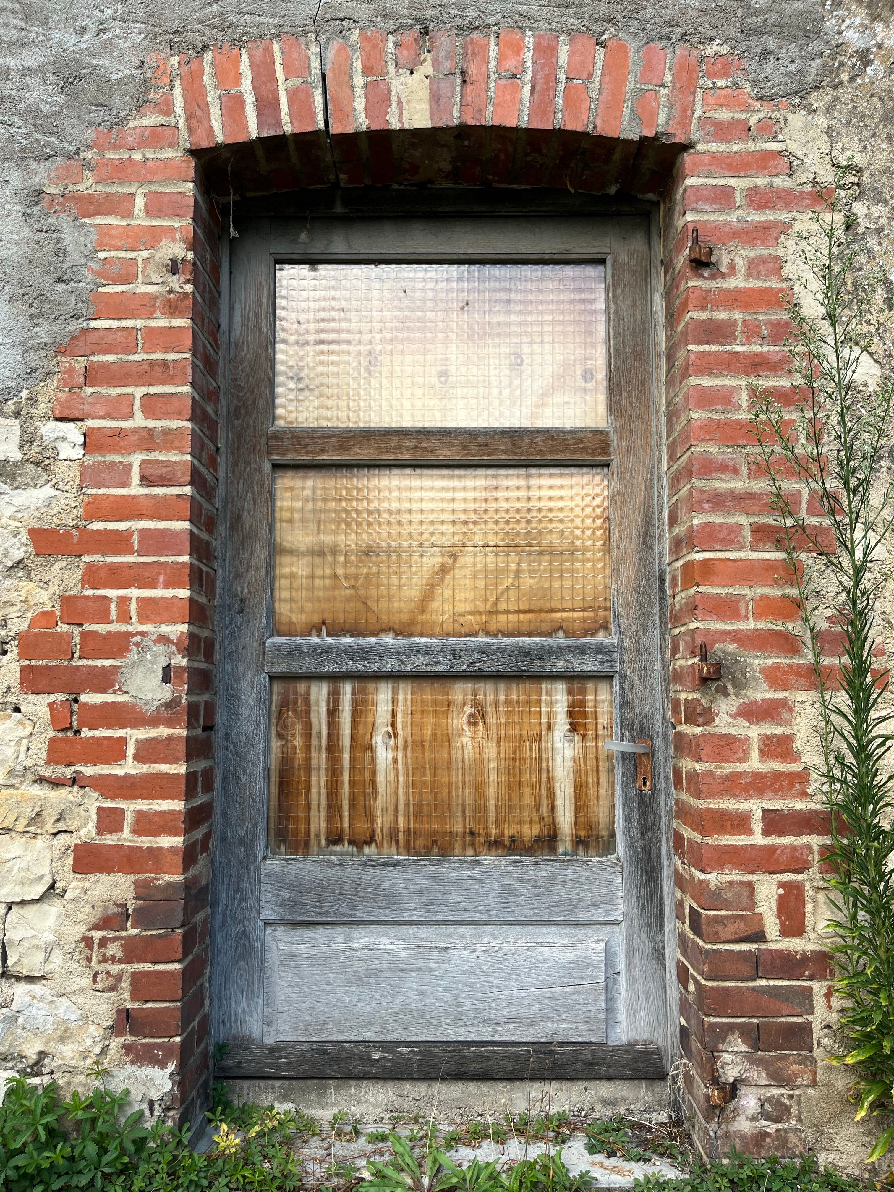 Rustic Wooden Door in Brick Wall Exterior · Free Stock Photo