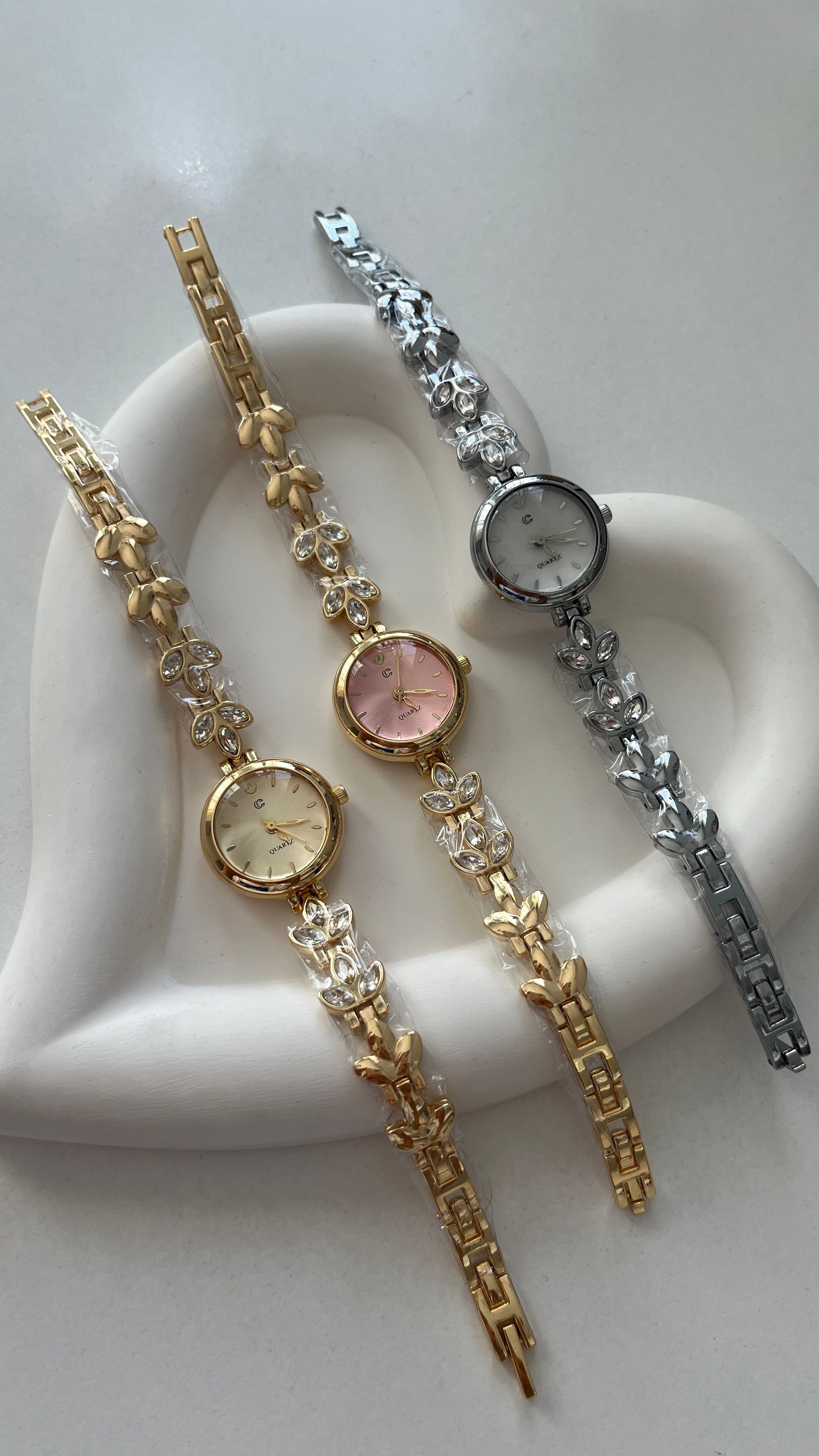Elegant Trio of Gold and Silver Watches on Heart Display · Free Stock Photo