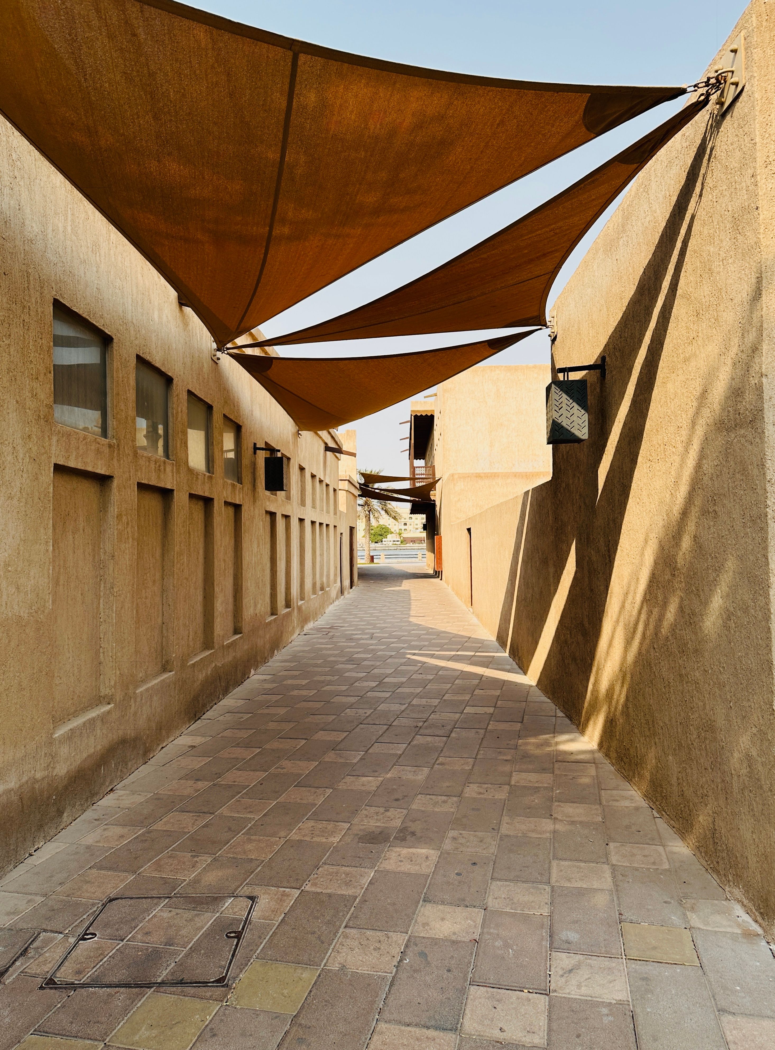 Modern Architectural Alley with Sunshade Sails · Free Stock Photo