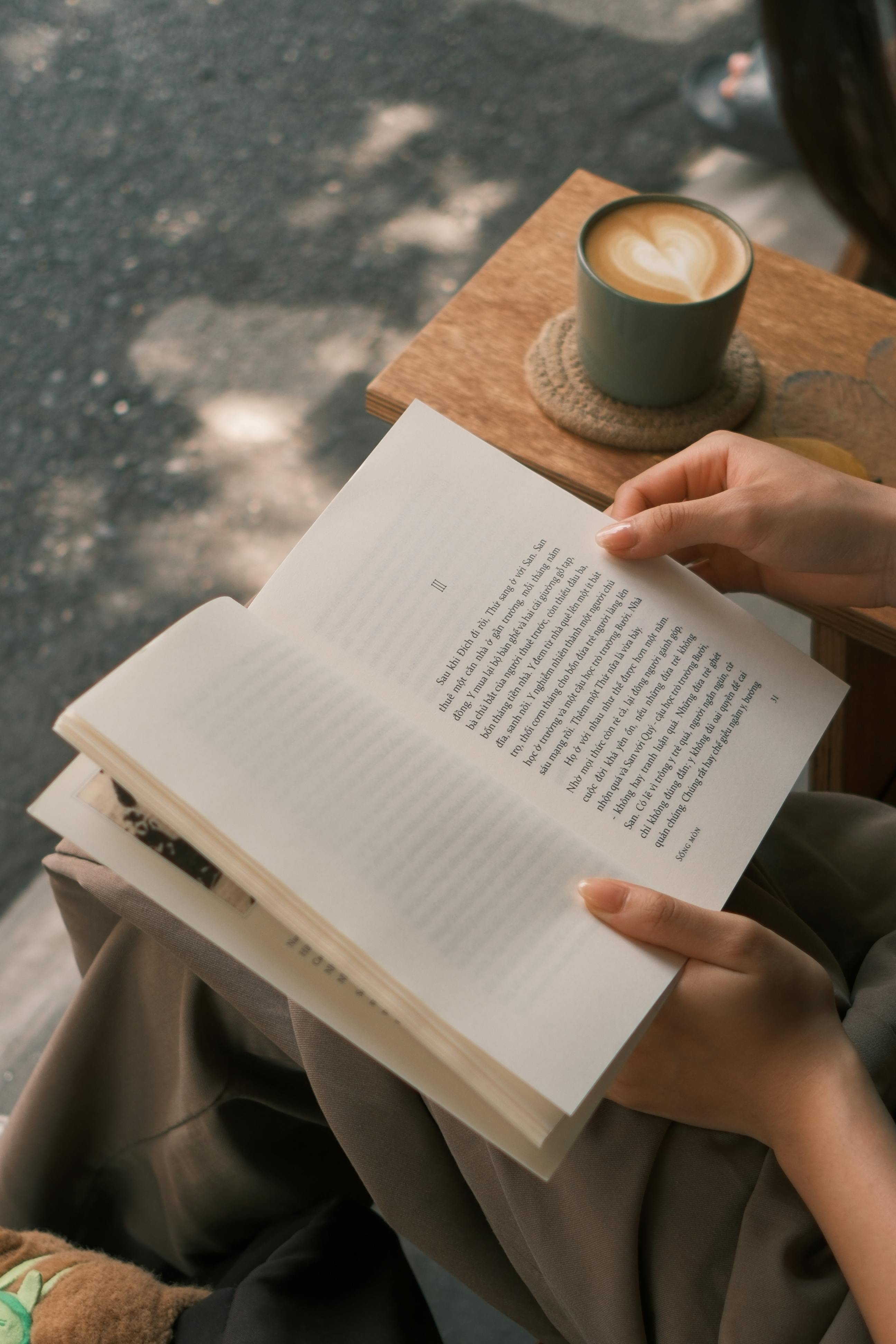 Relaxing Outdoor Reading with Coffee in Hanoi · Free Stock Photo