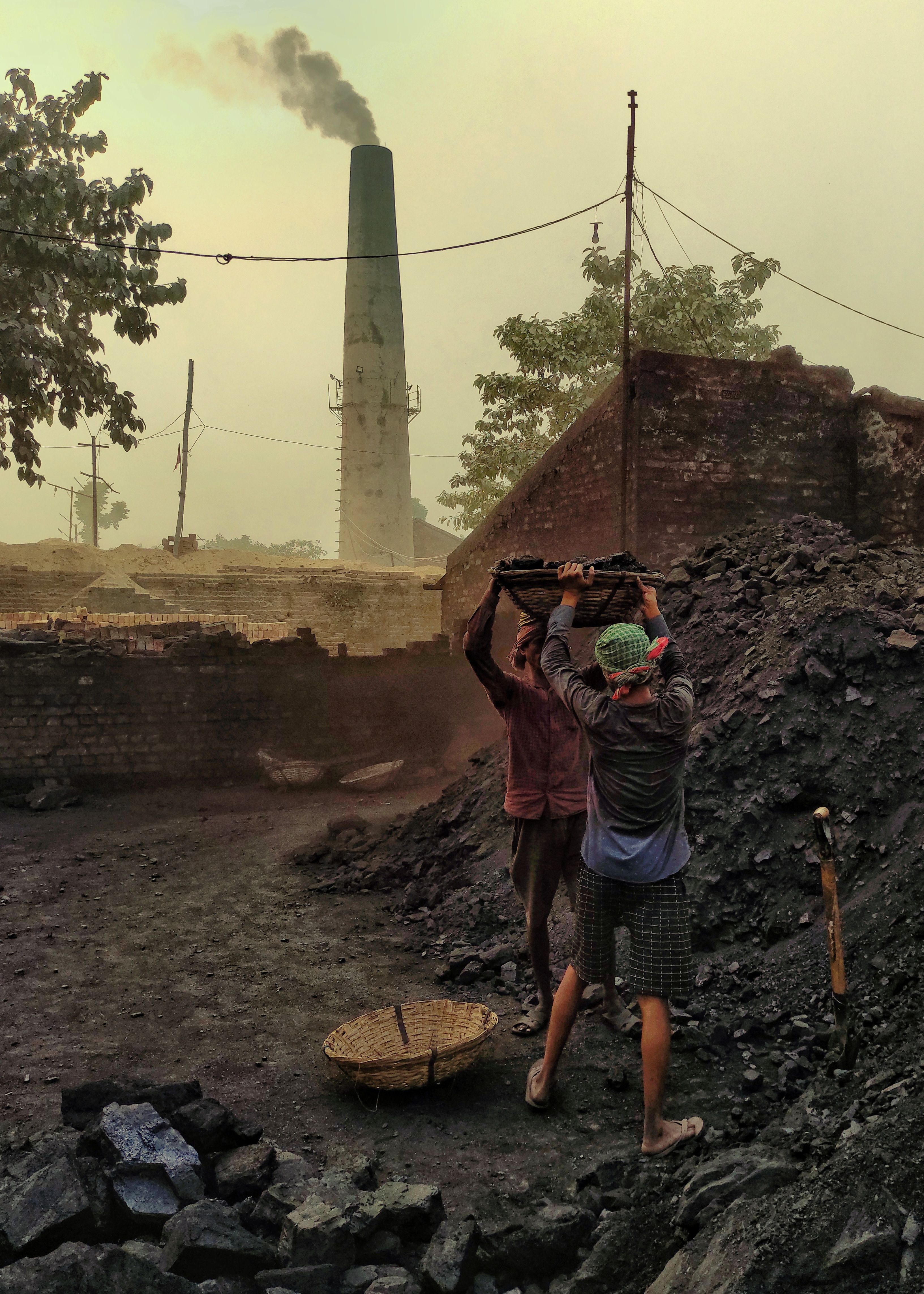 Two Workers Loading Coal Near Industrial Chimney · Free Stock Photo