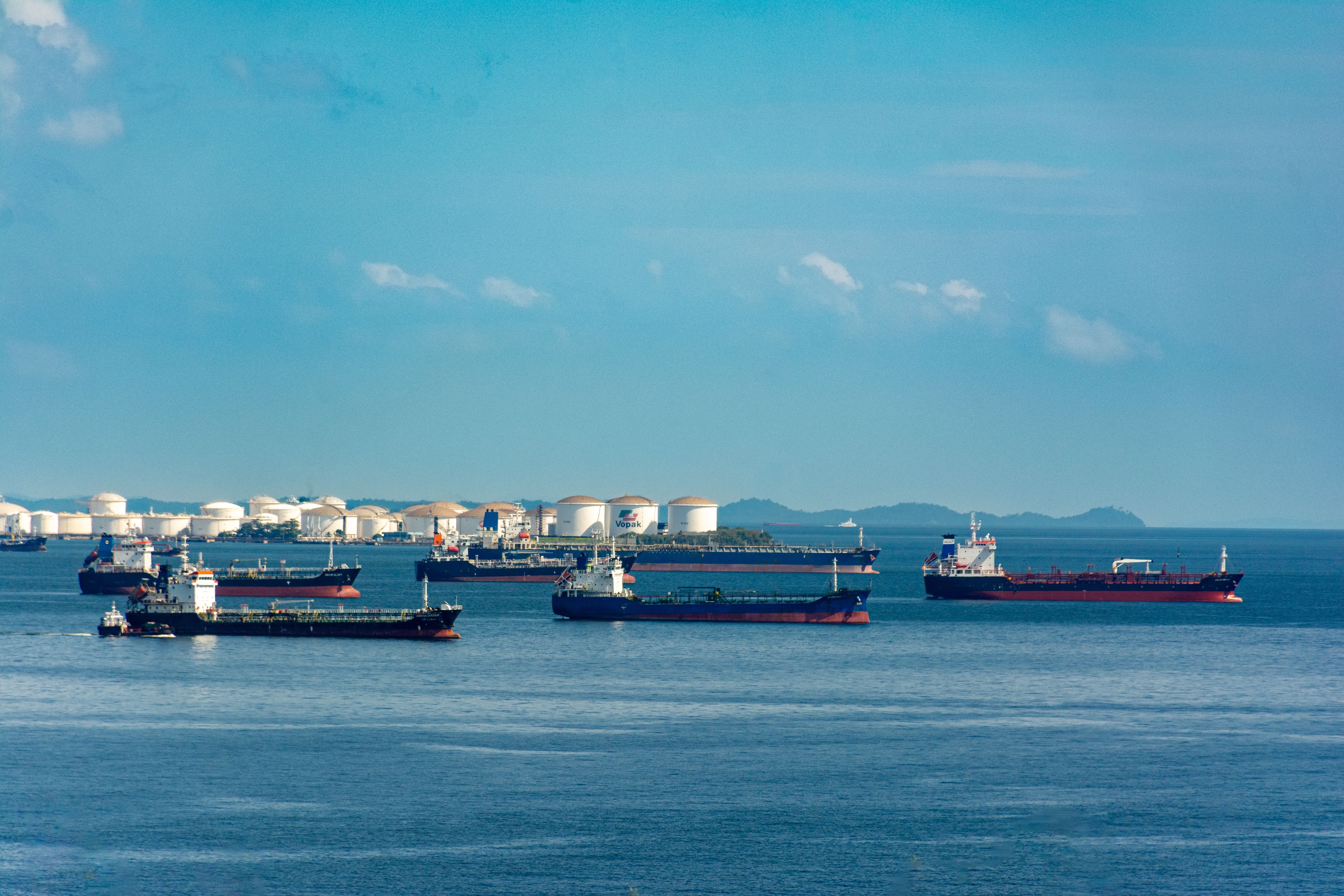 Cargo Ships Anchored at Coastal Port under Blue Sky · Free Stock Photo