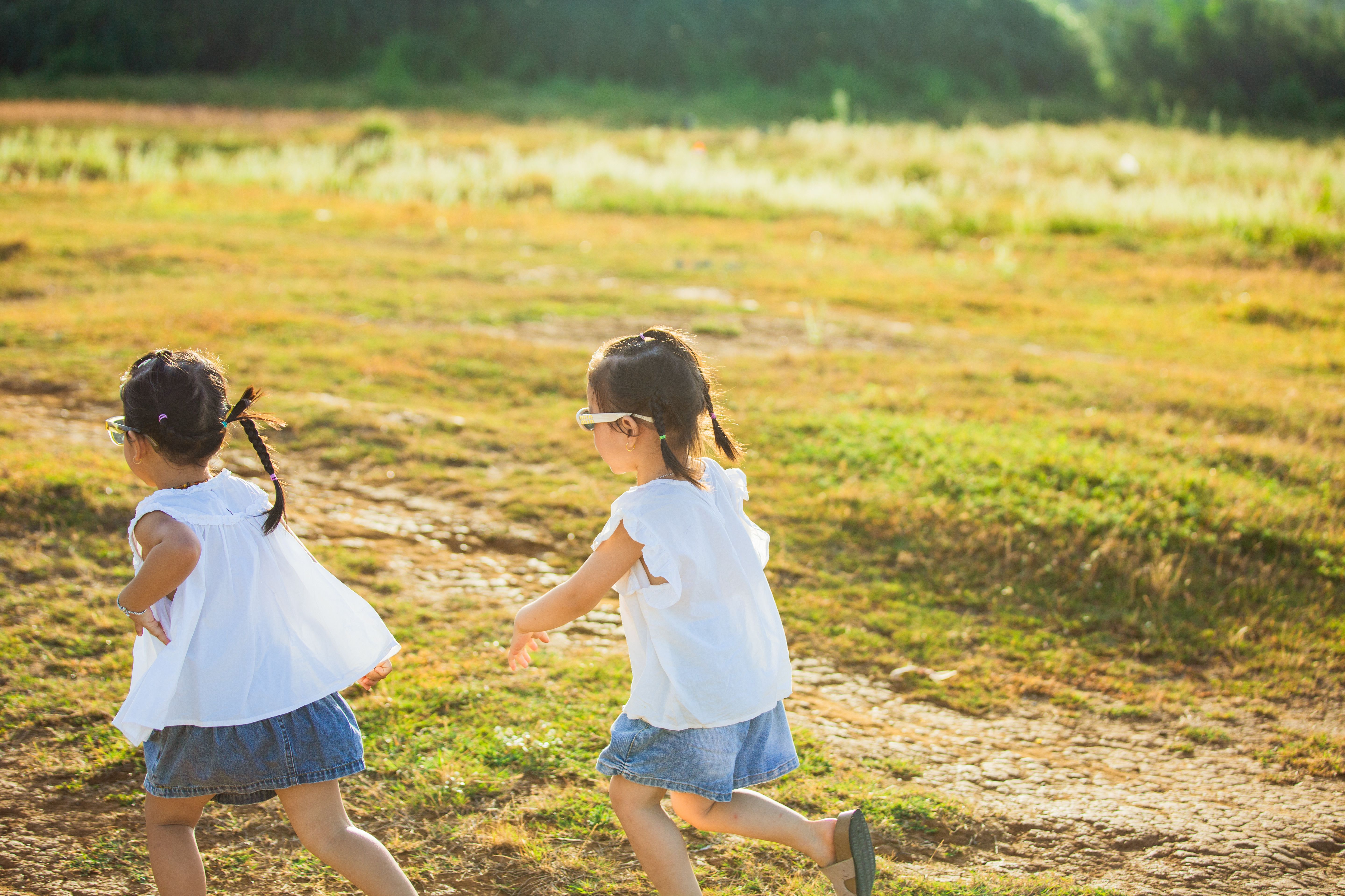 Two young girls playing outdoors in summer sun · Free Stock Photo