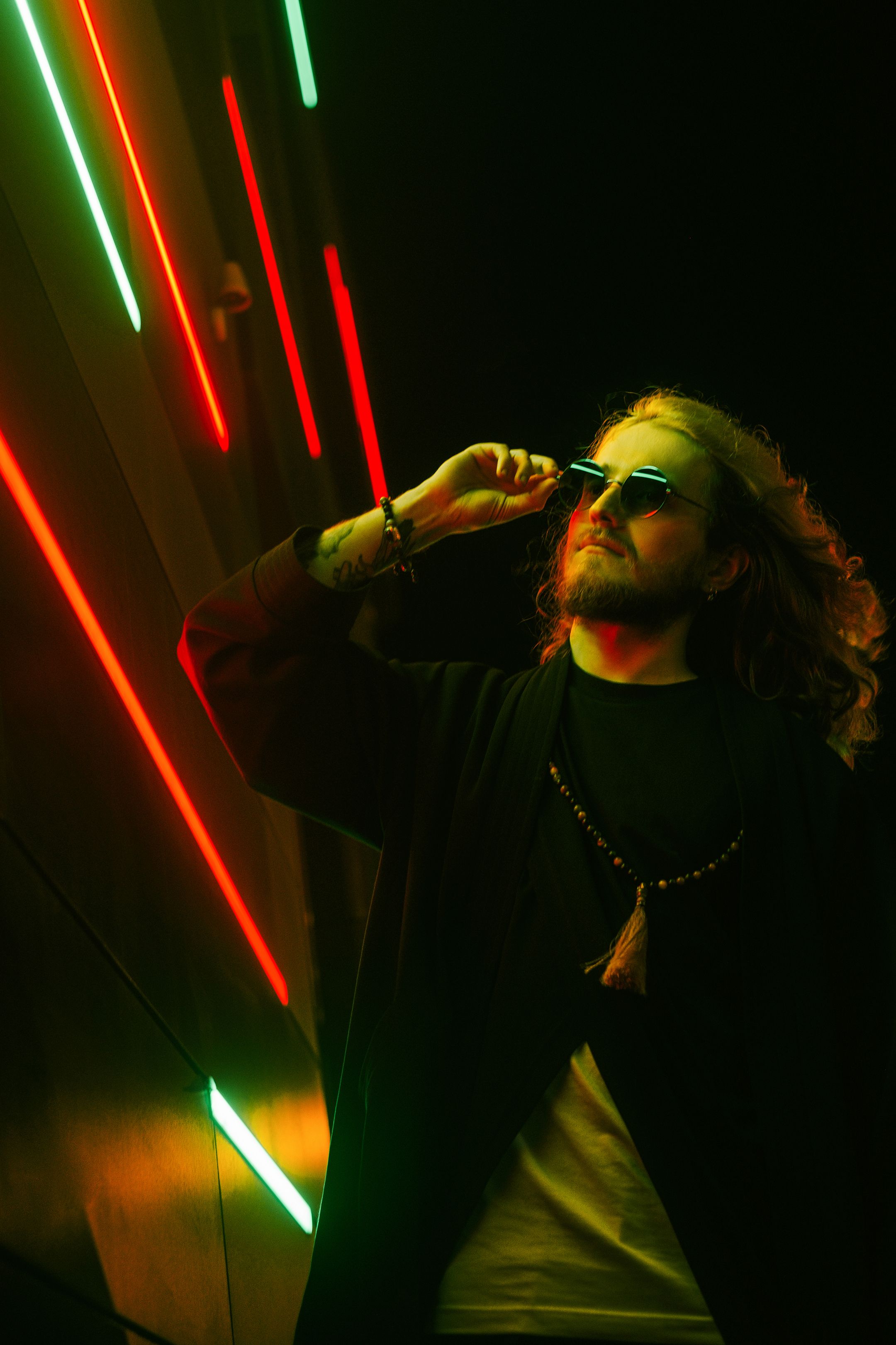Stylish Man Posing Under Neon Lights · Free Stock Photo