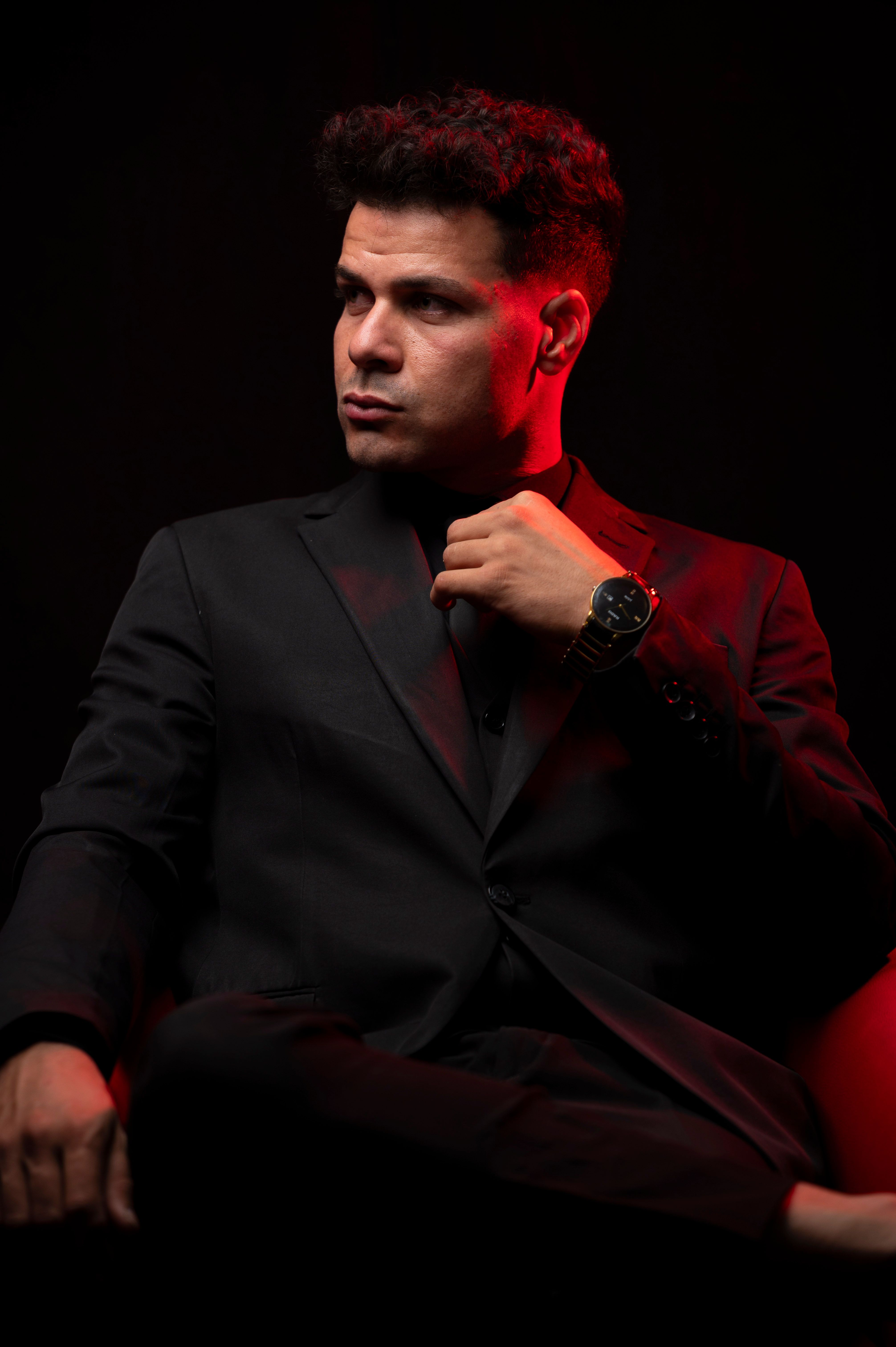 Stylish Man in Black Suit with Red Lighting · Free Stock Photo