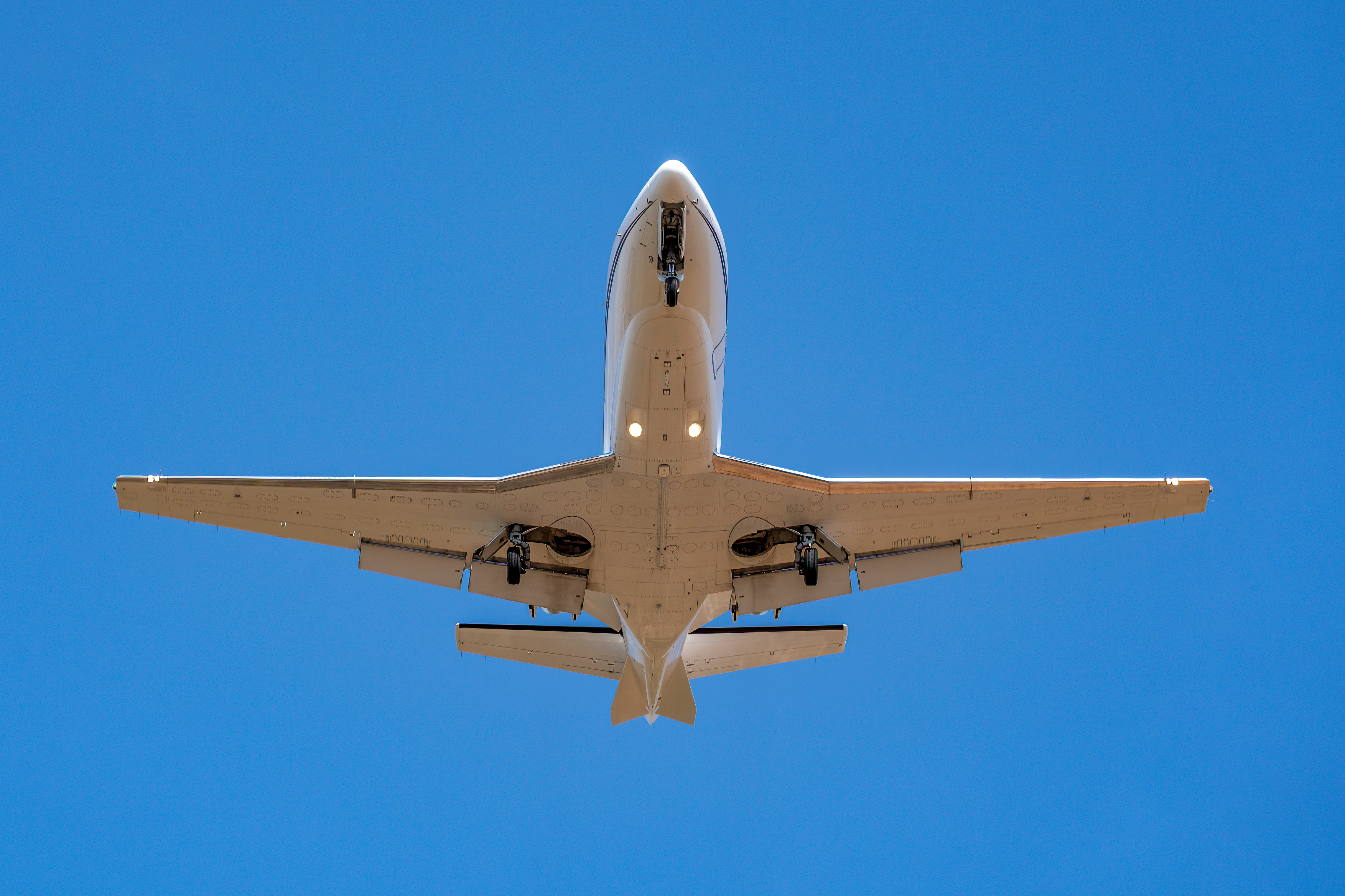 Private Jet Flying Above with Blue Sky · Free Stock Photo