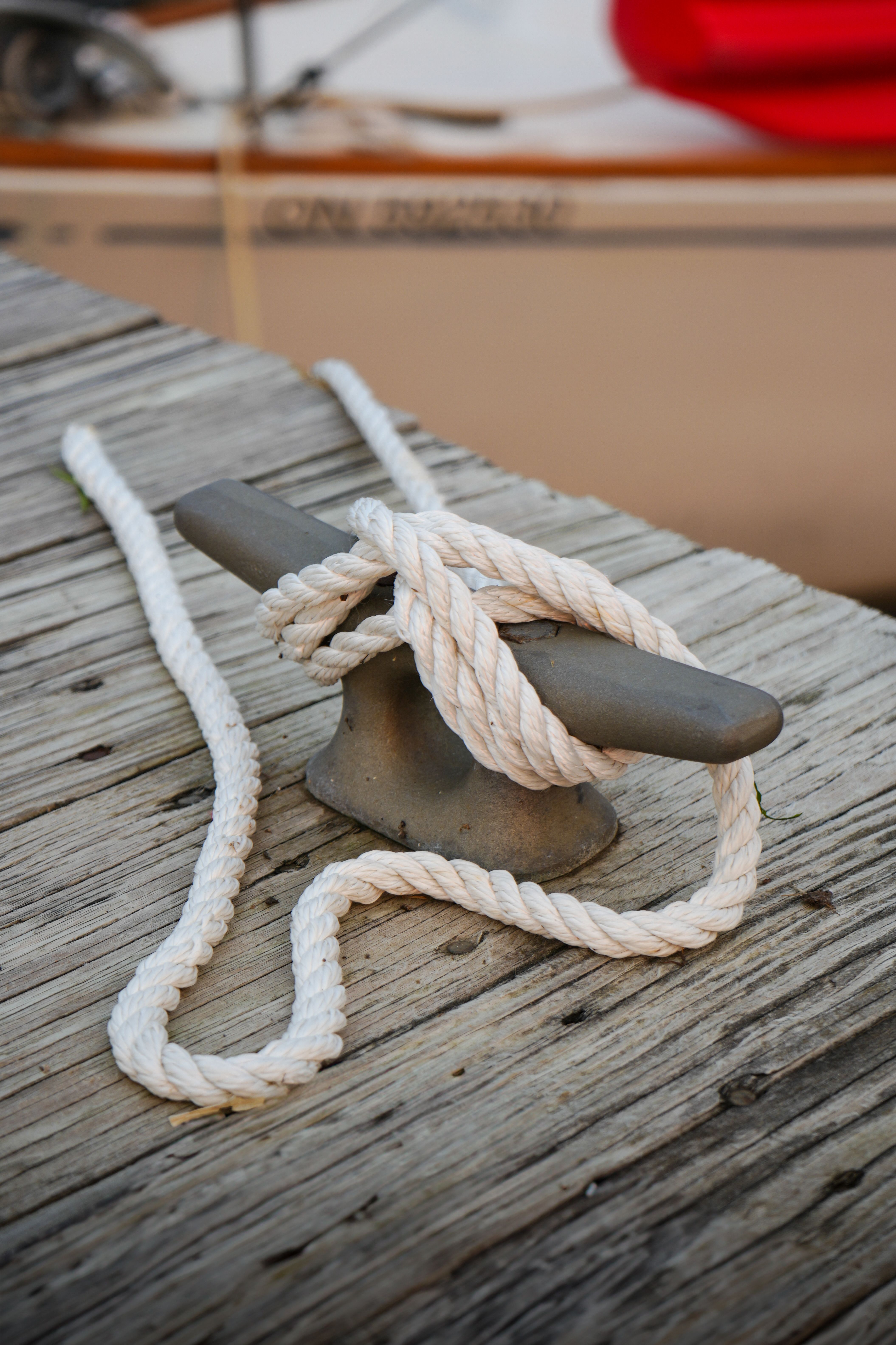 Close-up of Nautical Rope on Dock Cleat by Boat · Free Stock Photo