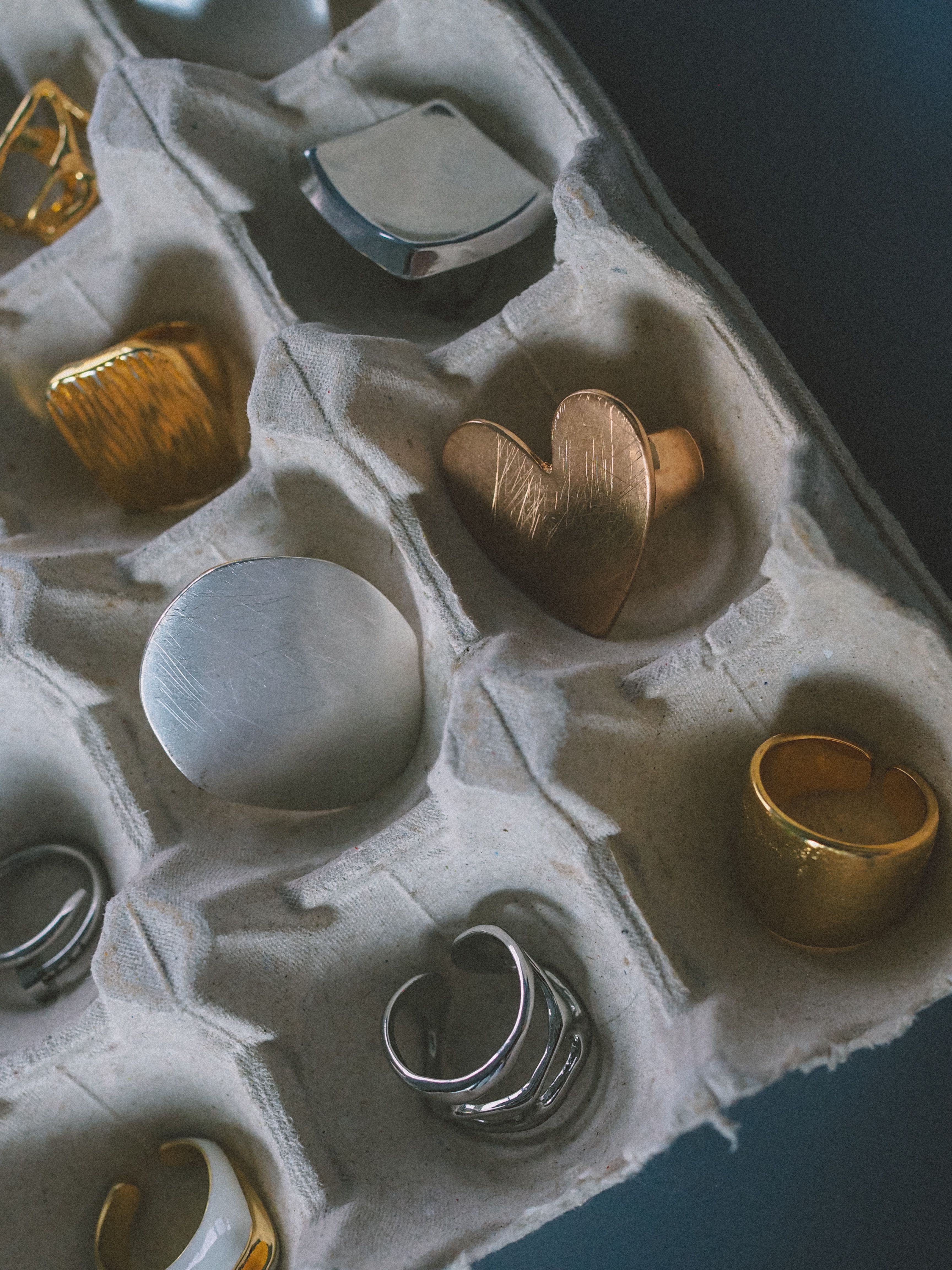 Assorted Metal Rings in Egg Carton Display · Free Stock Photo