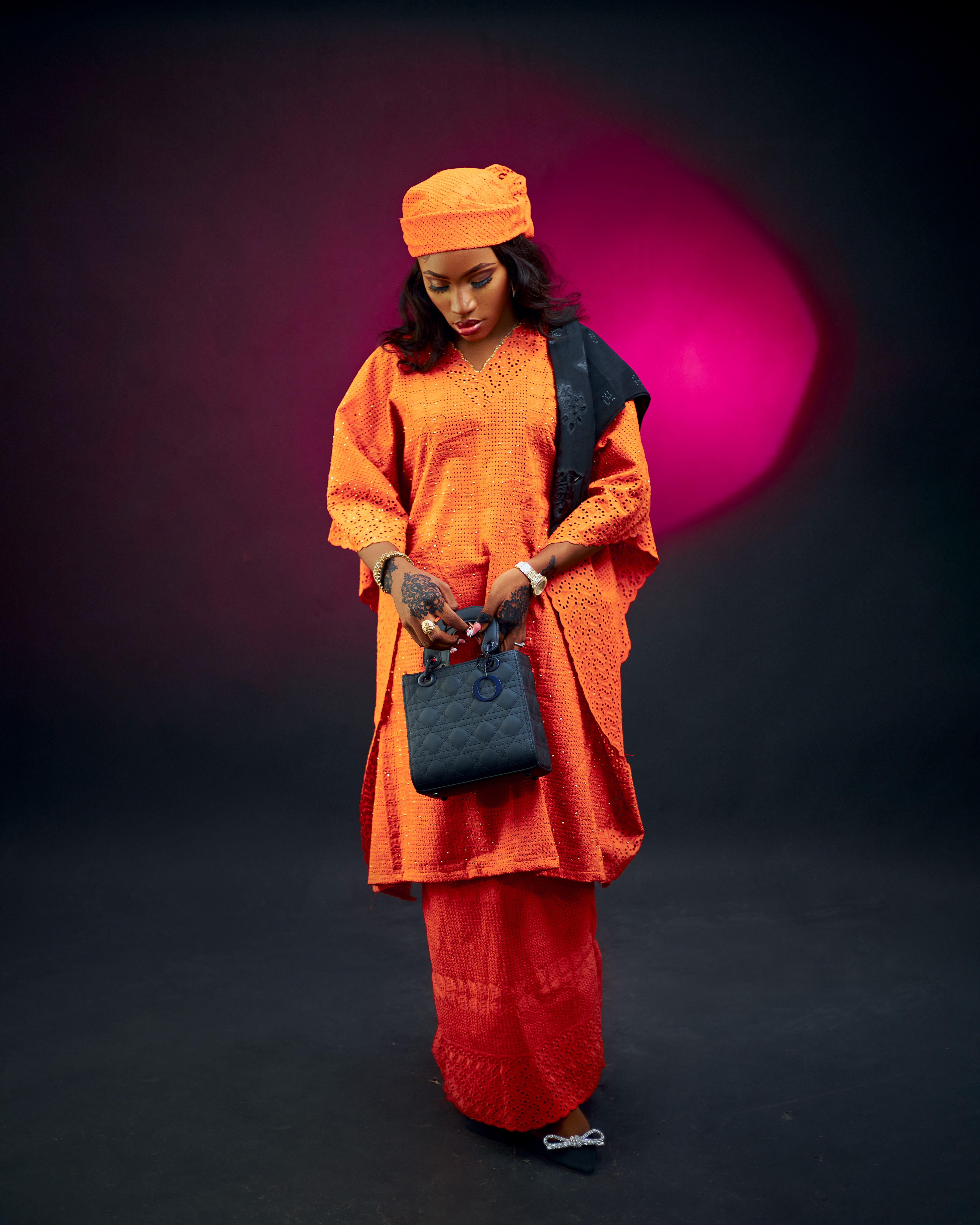 Elegant Woman in Traditional Orange Attire Posing · Free Stock Photo