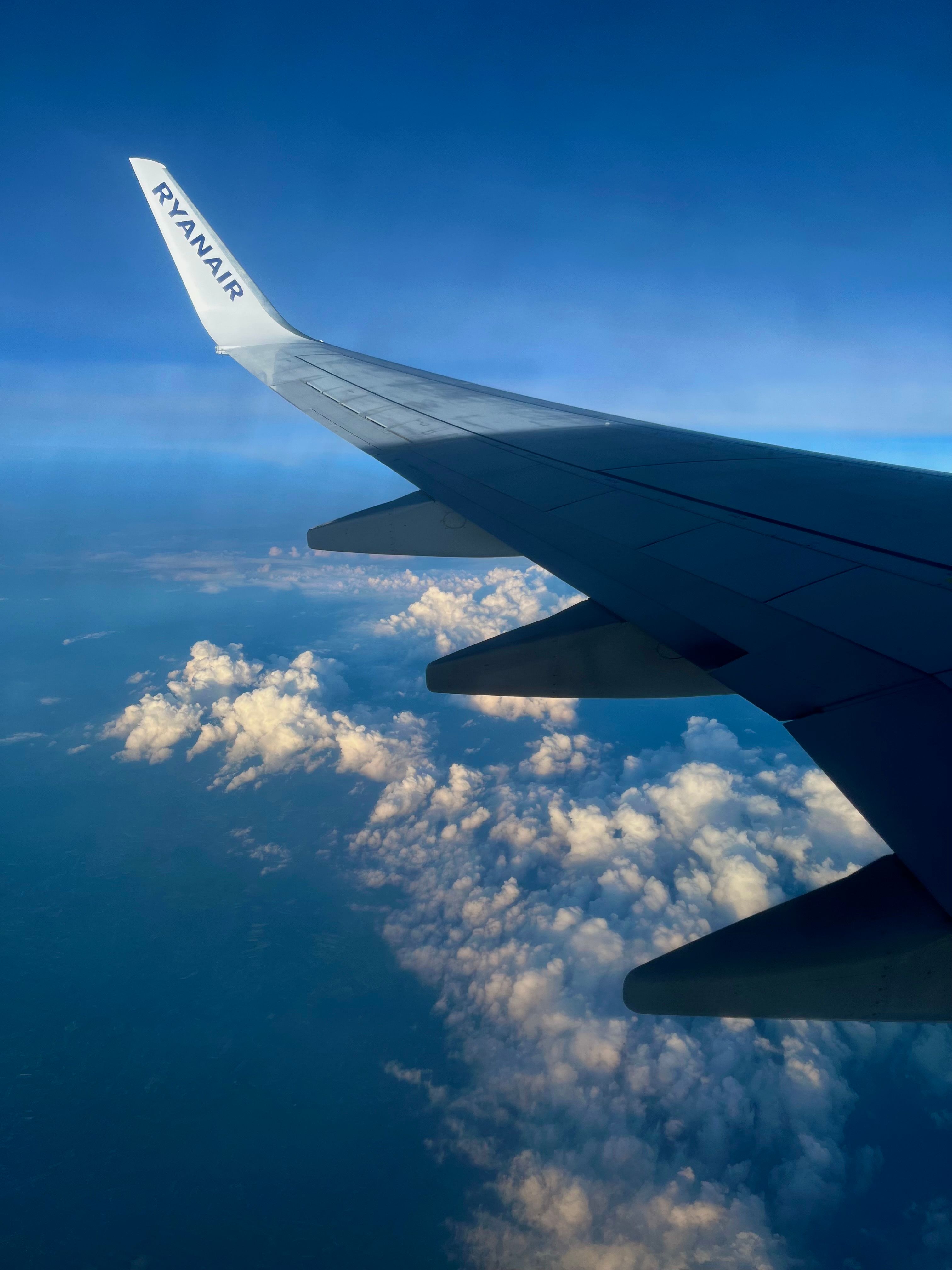 Airplane Wing View Over Fluffy Clouds · Free Stock Photo