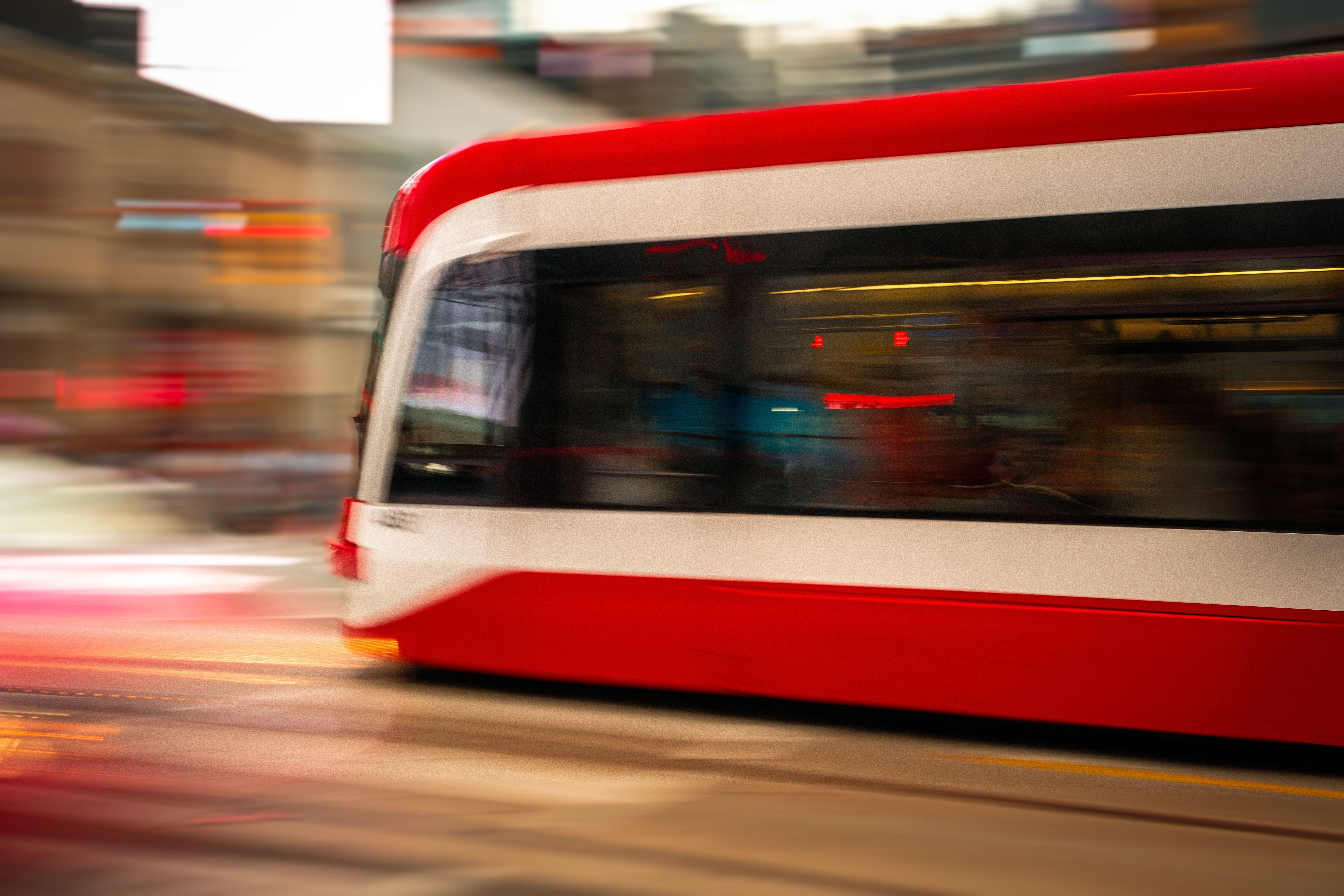 Dynamic Red Tram in Motion on City Streets · Free Stock Photo