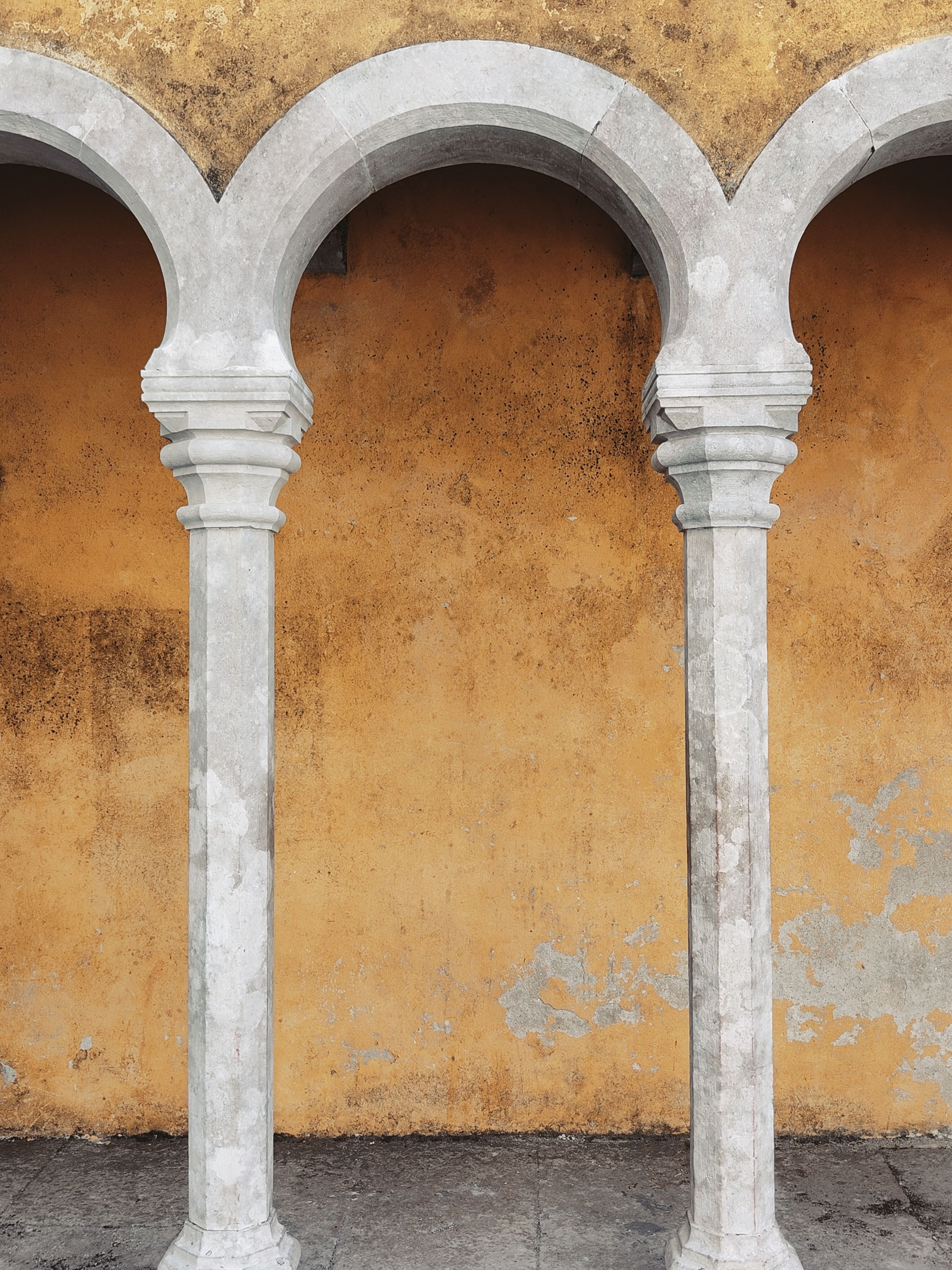 Classic Stone Archways against Weathered Wall · Free Stock Photo